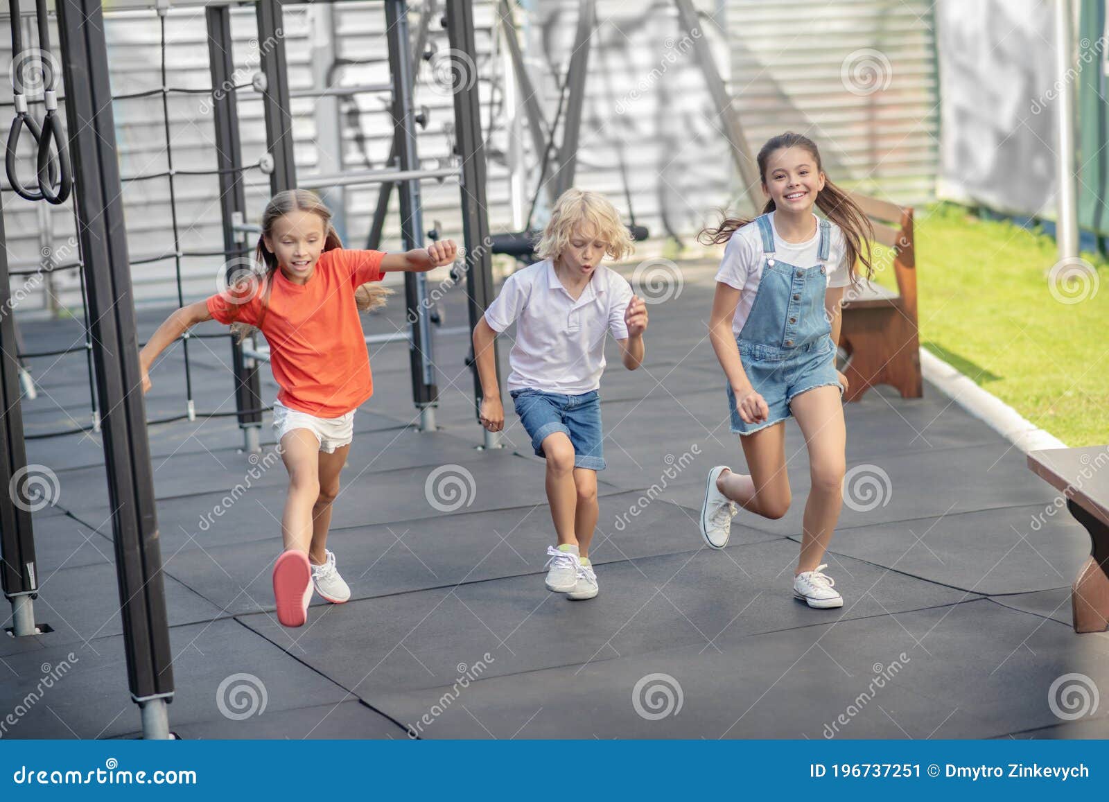 Three Friends Running at the Playground and Feeling Excited Stock Image ...