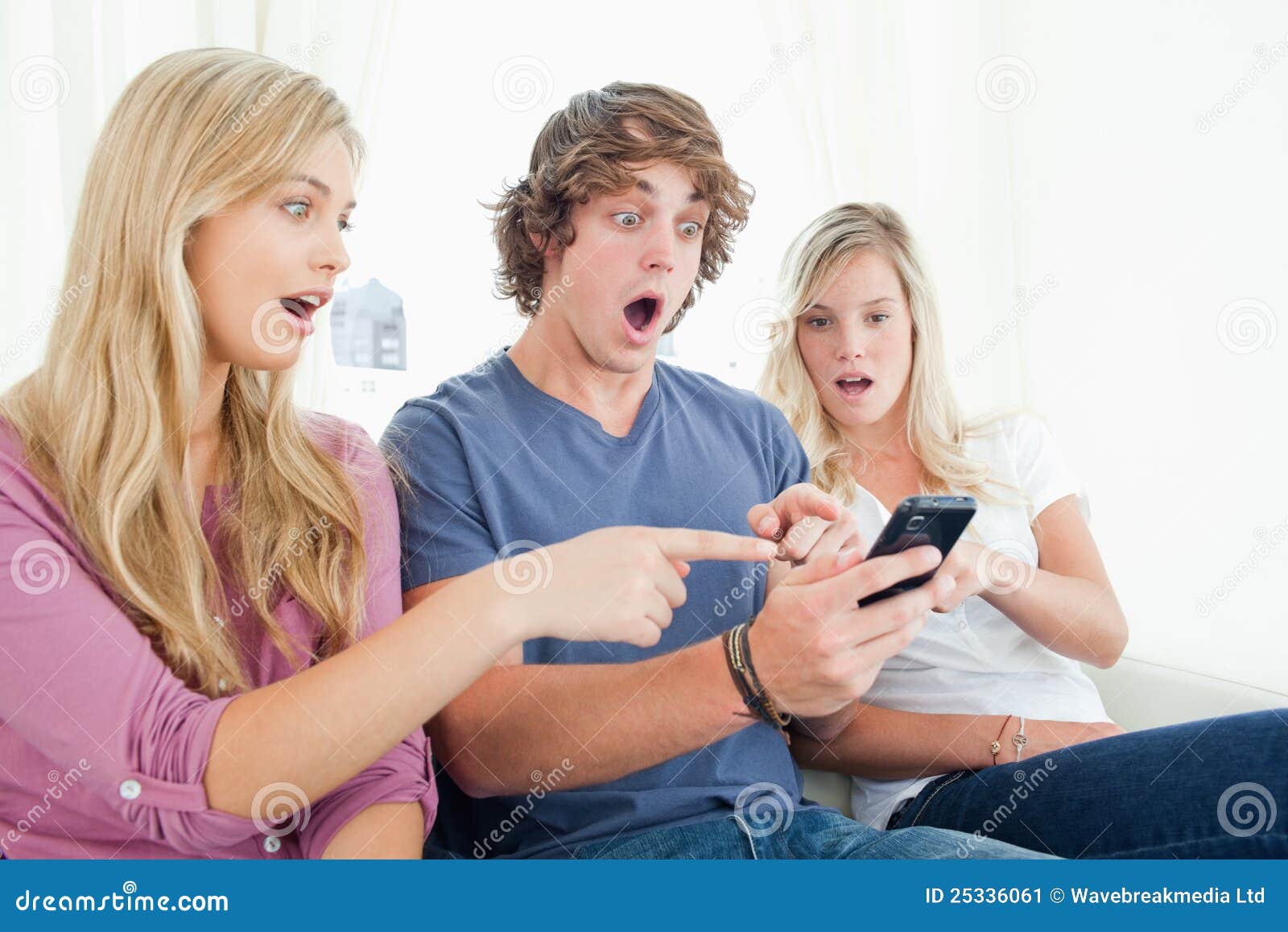 Three Friends Shocked at the Message on the Phone Stock Image - Image ...