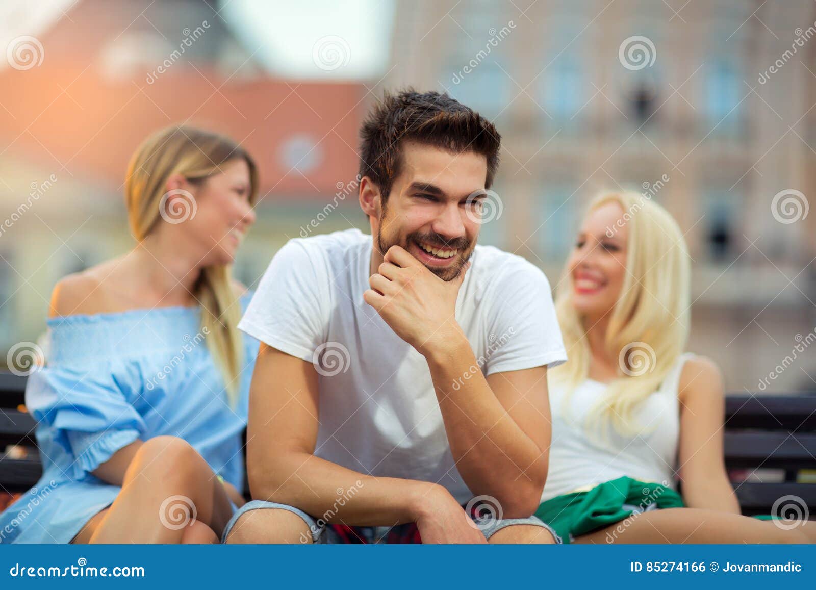 Three Friends Sitting on a Bench and Having Fun Stock Photo - Image of ...
