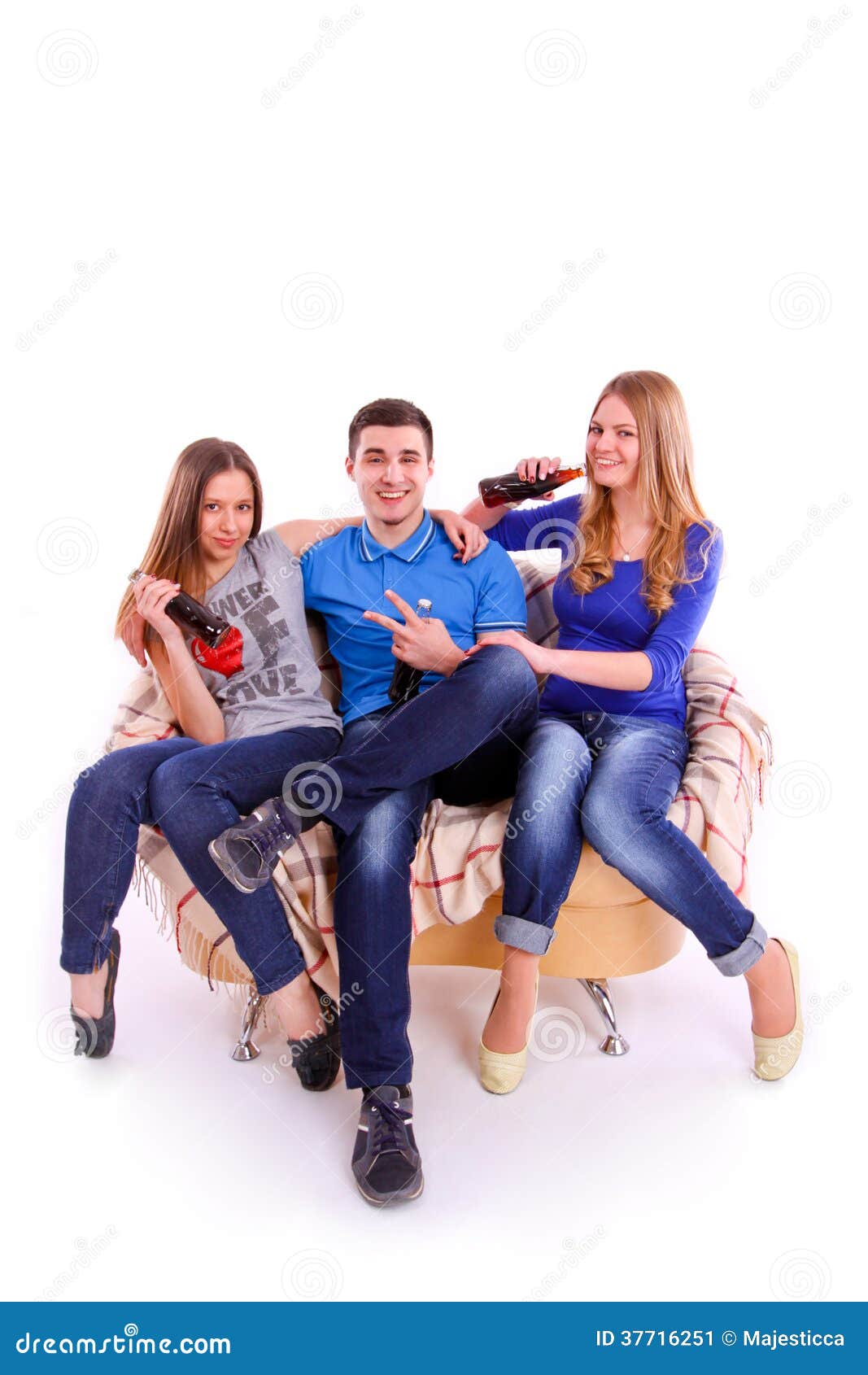 Three Friends Sitting on a Couch and Drinking a Soda Stock Image ...