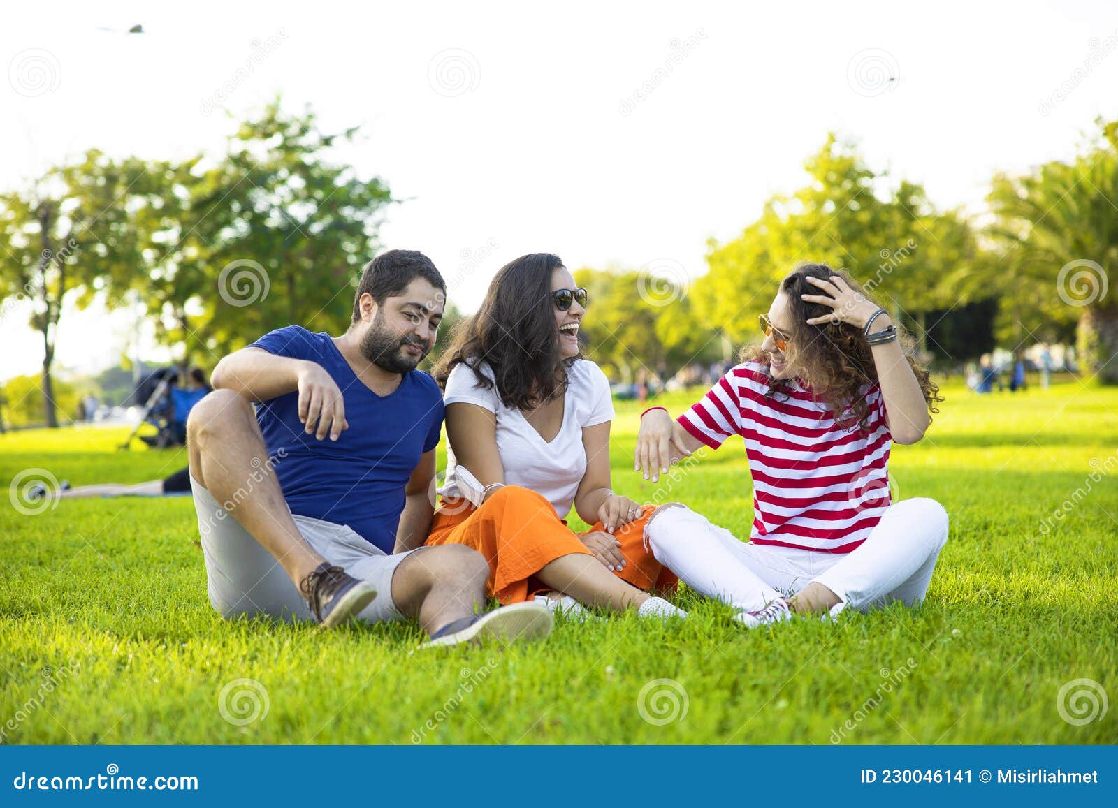 Three Friends Sitting on the Grass in the Park Stock Image - Image of ...