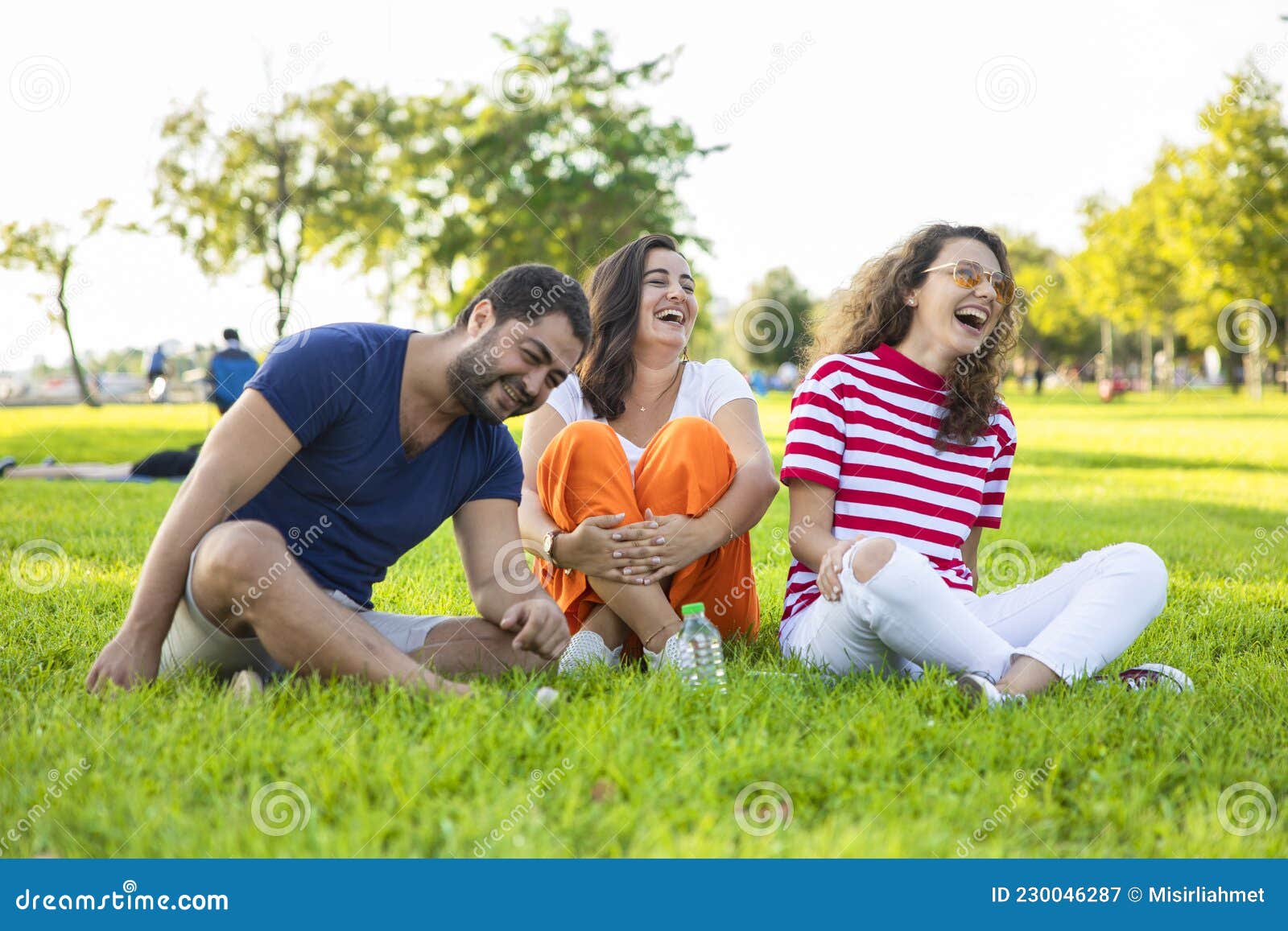 Three Friends Sitting on the Grass in the Park Stock Image - Image of ...
