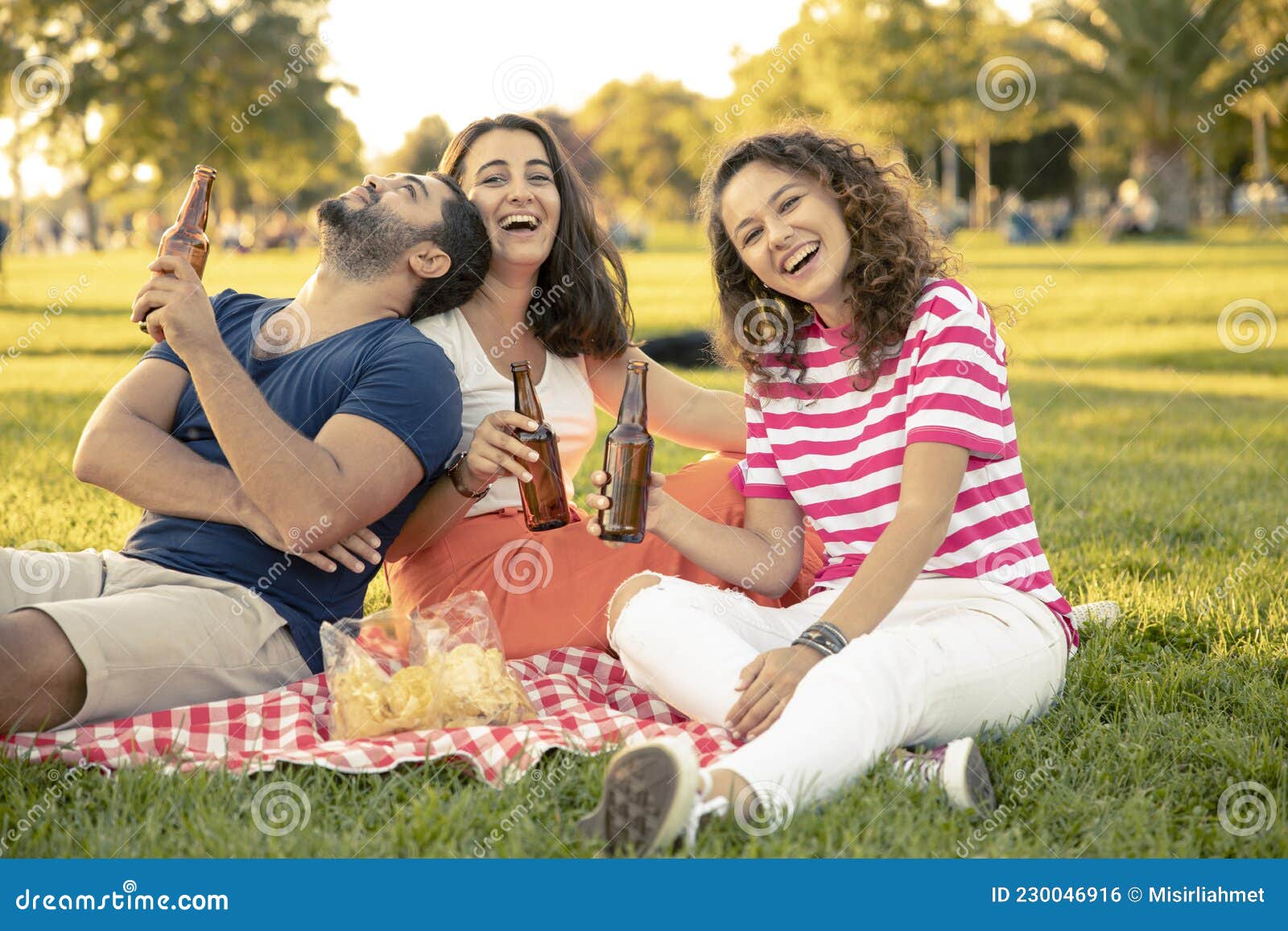 Three Friends Sitting on the Grass in the Park Stock Photo - Image of ...