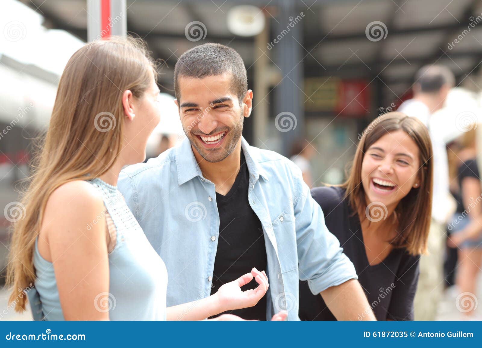 Three Friends Talking and Laughing in a Train Station Stock Image ...