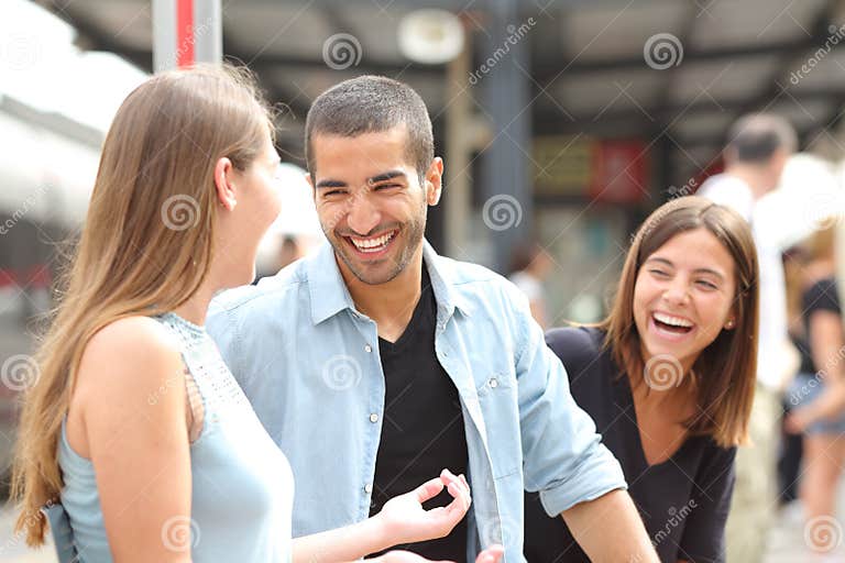 Three Friends Talking and Laughing in a Train Station Stock Image ...