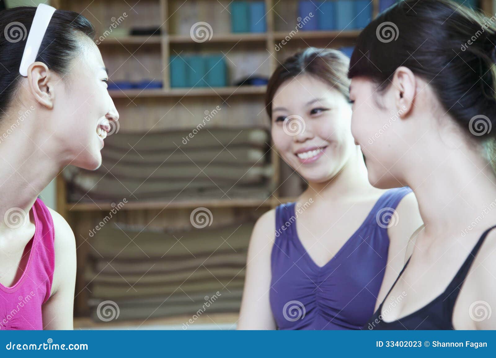 Three Friends Talking and Smiling in a Yoga Studio Stock Image - Image ...