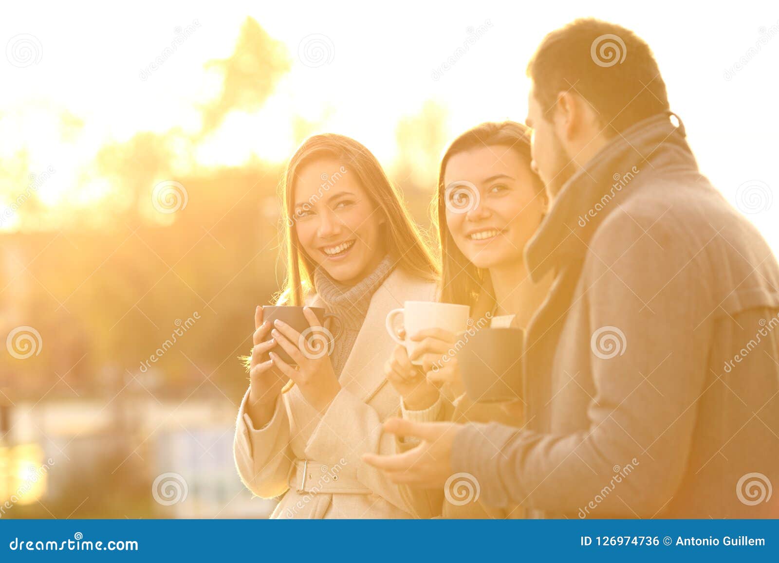 Three Friends Talking at Sunset in Winter Stock Photo - Image of ...