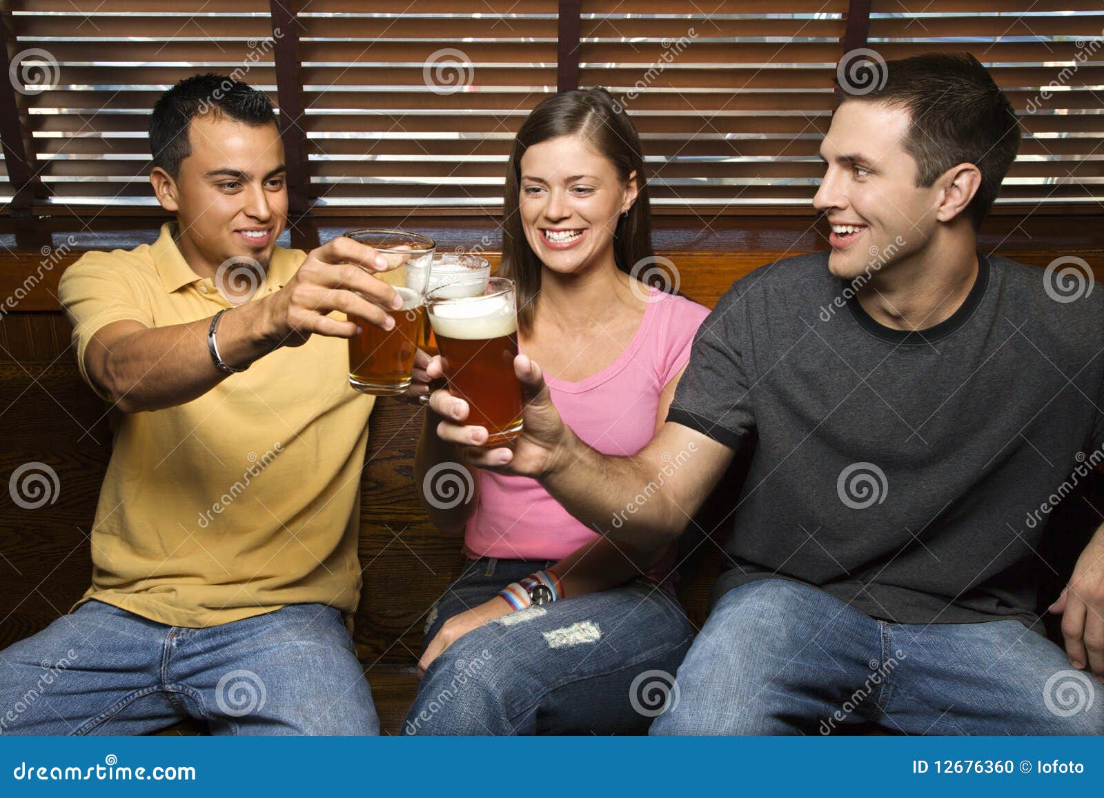 Three Friends Toasting with Beers Stock Photo - Image of people ...