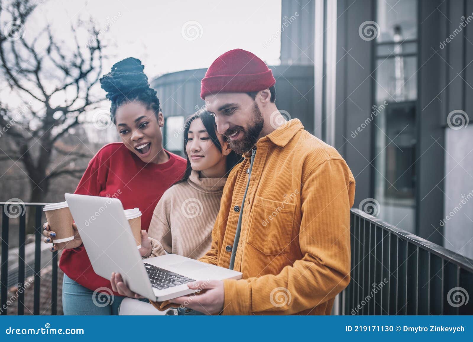 Three Friends Watching Something Online and Feeling Interested Stock ...