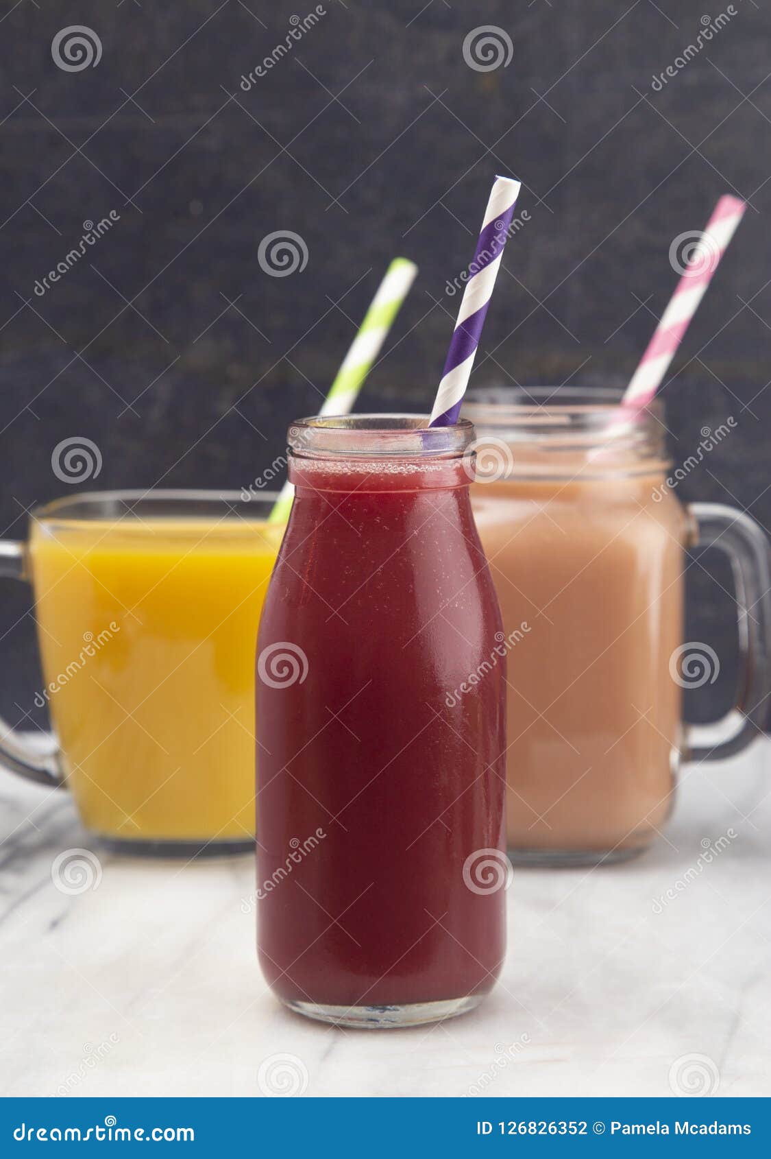 Three Fruit Smoothies in Various Cups with Paper Straws Stock Photo ...