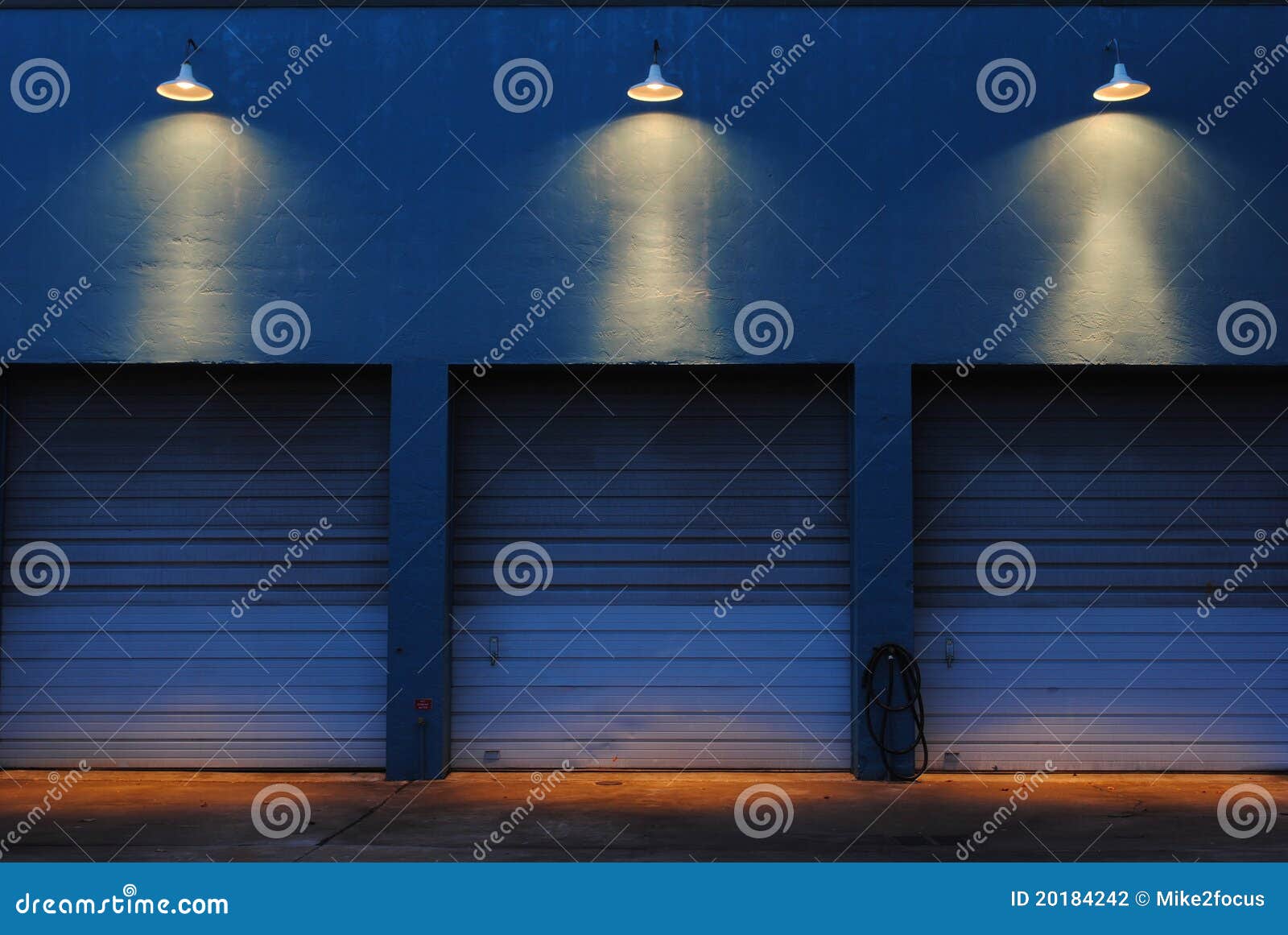 Three Garage Doors at Night W Outdoor Lighting Stock Photo - Image of ...