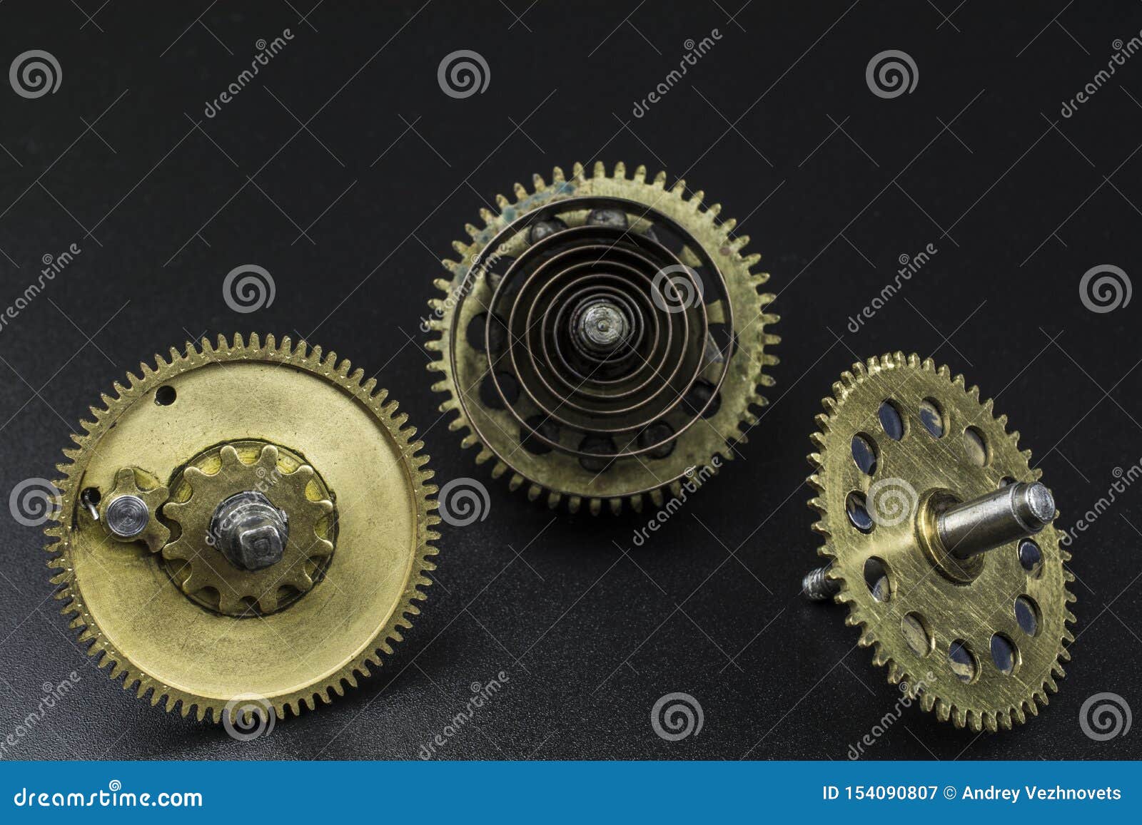 Three Gears Made of Bronze Lie on a Black Background Stock Image ...