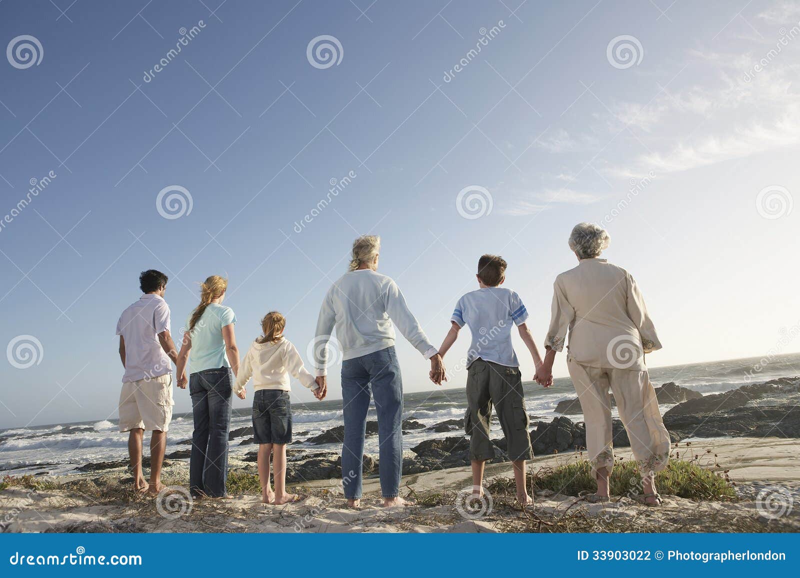 Three Generation Family Holding Hands on Seashore Stock Photo - Image ...