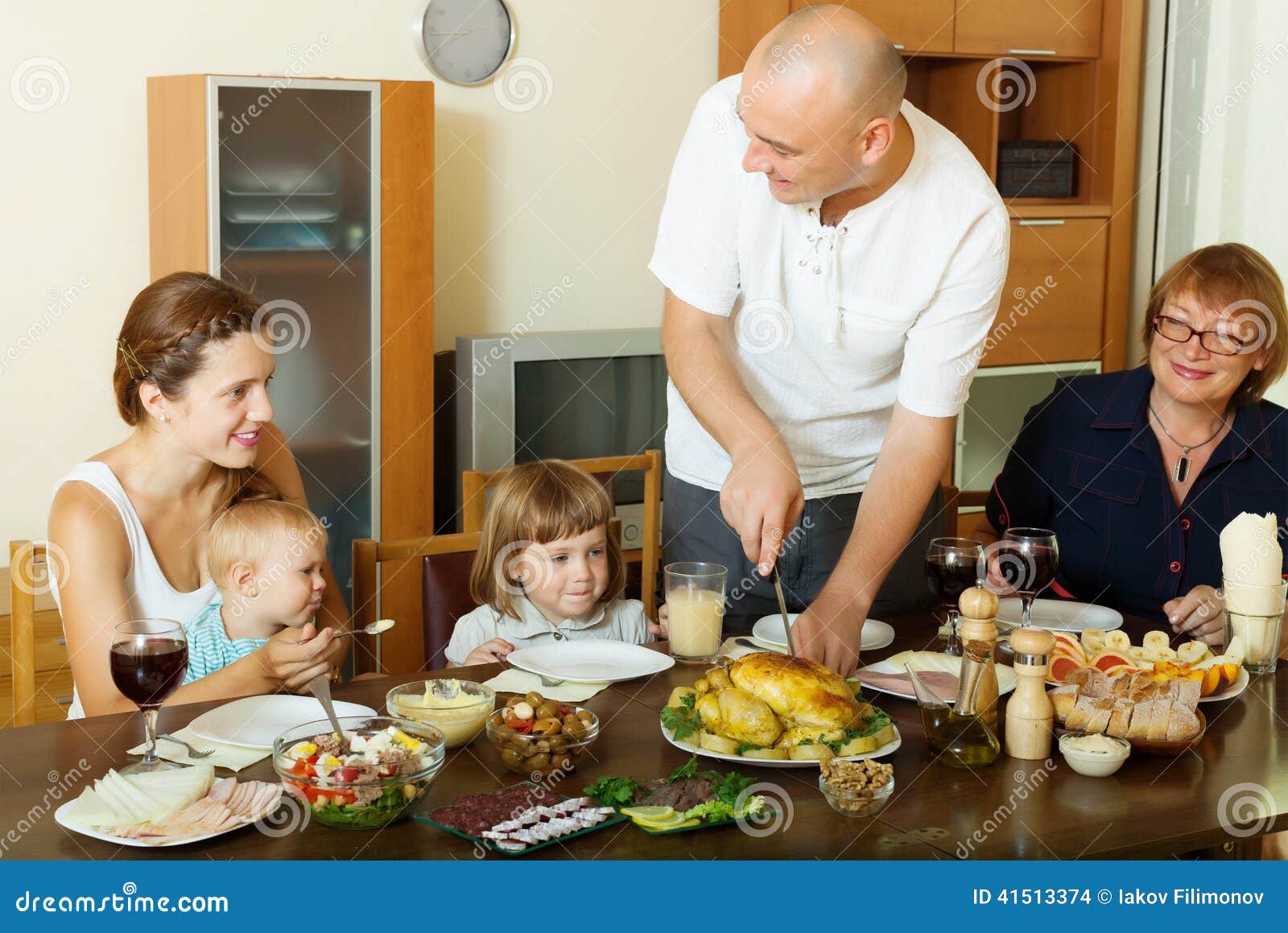 Three Generations Family Around Festive Table Stock Photo - Image of ...