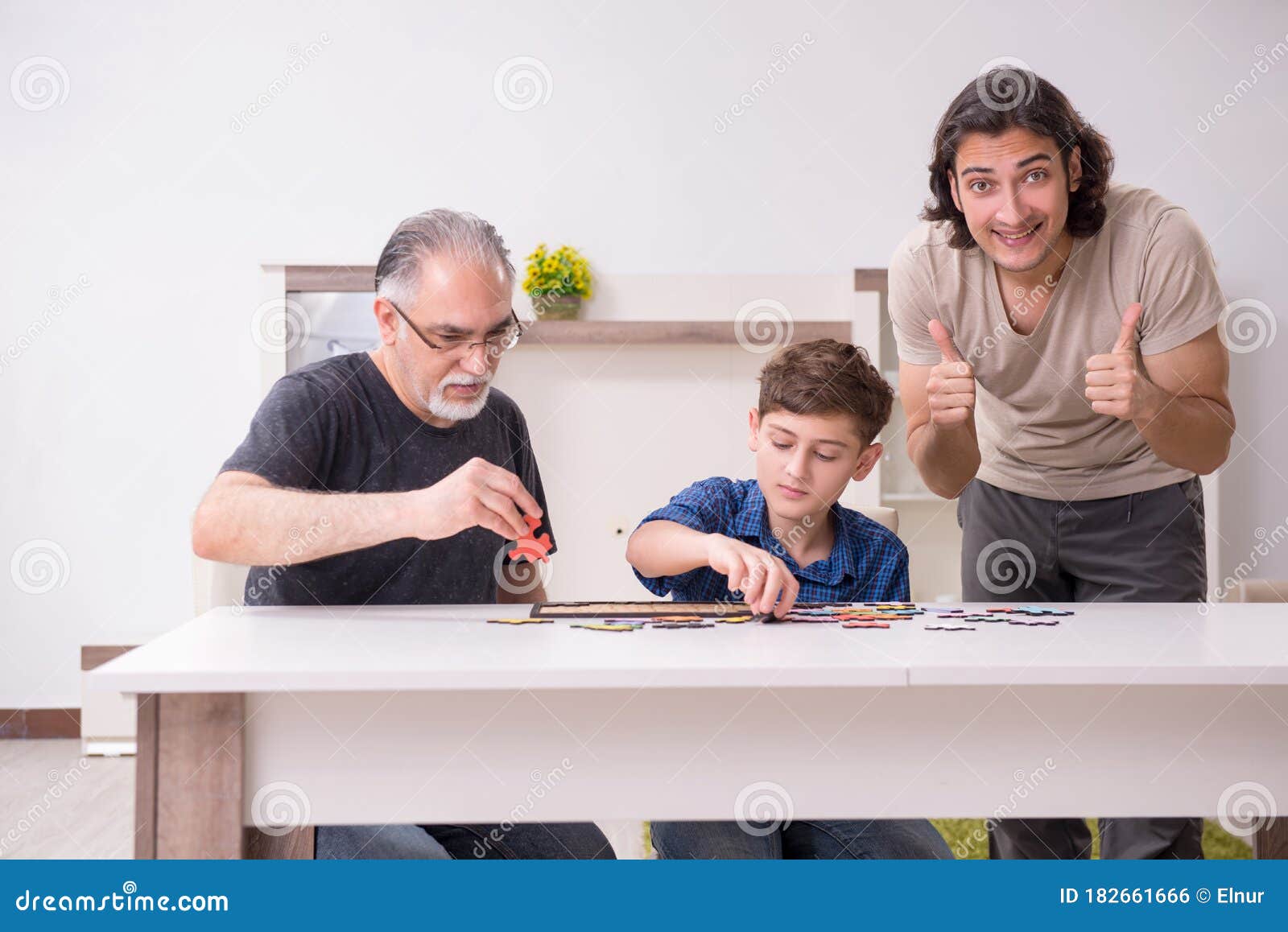 Three Generations of Family Playing Jigsaw Puzzle Game Stock Photo ...