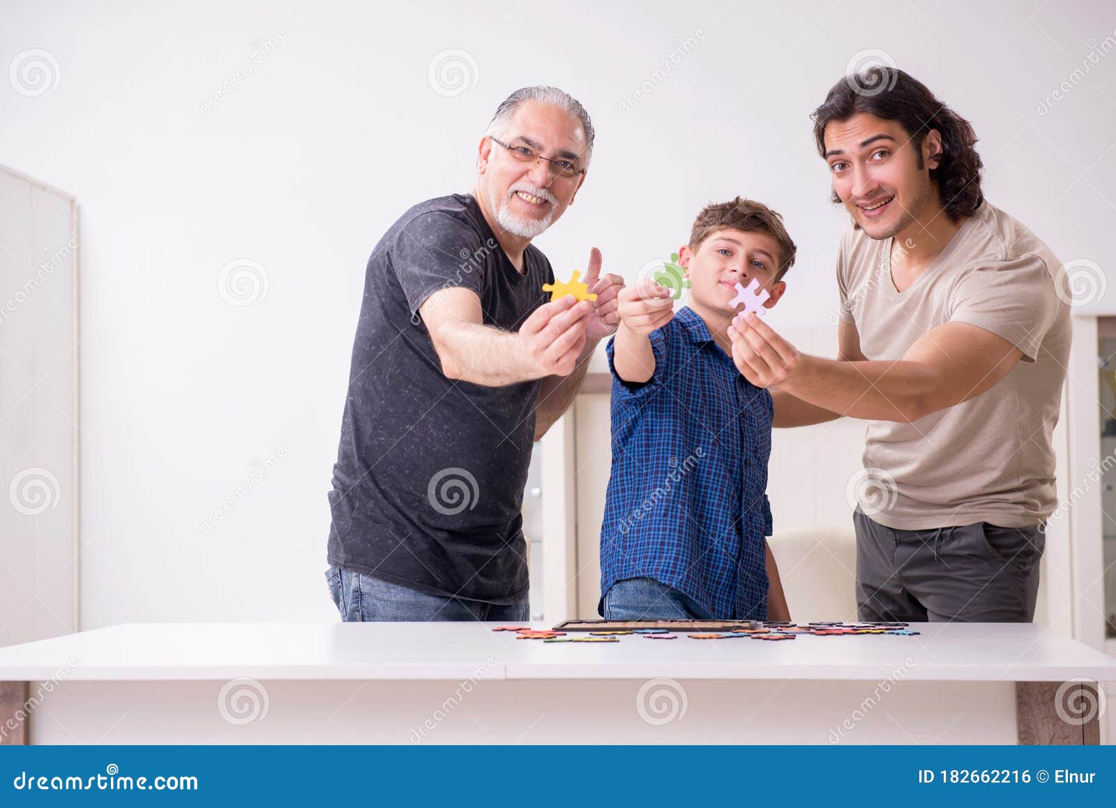 Three Generations of Family Playing Jigsaw Puzzle Game Stock Photo ...