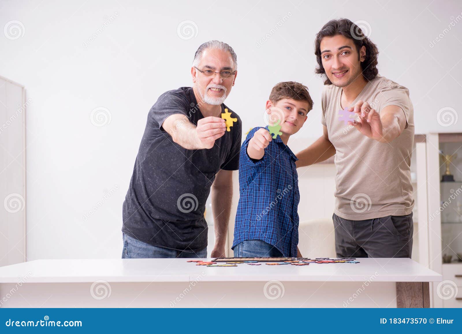 Three Generations of Family Playing Jigsaw Puzzle Game Stock Photo ...