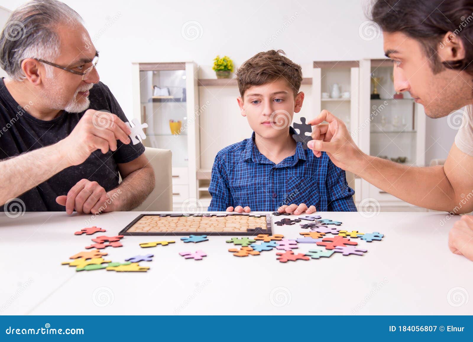 Three Generations of Family Playing Jigsaw Puzzle Game Stock Image ...