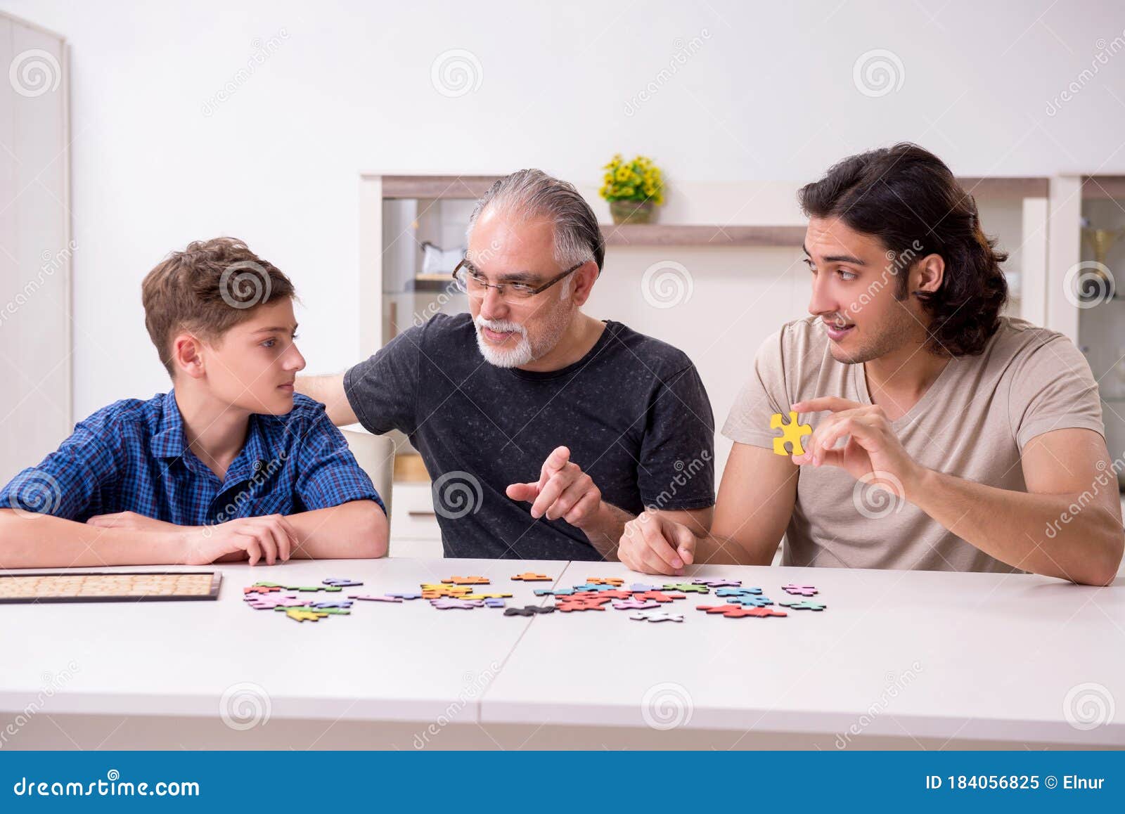 Three Generations of Family Playing Jigsaw Puzzle Game Stock Image ...