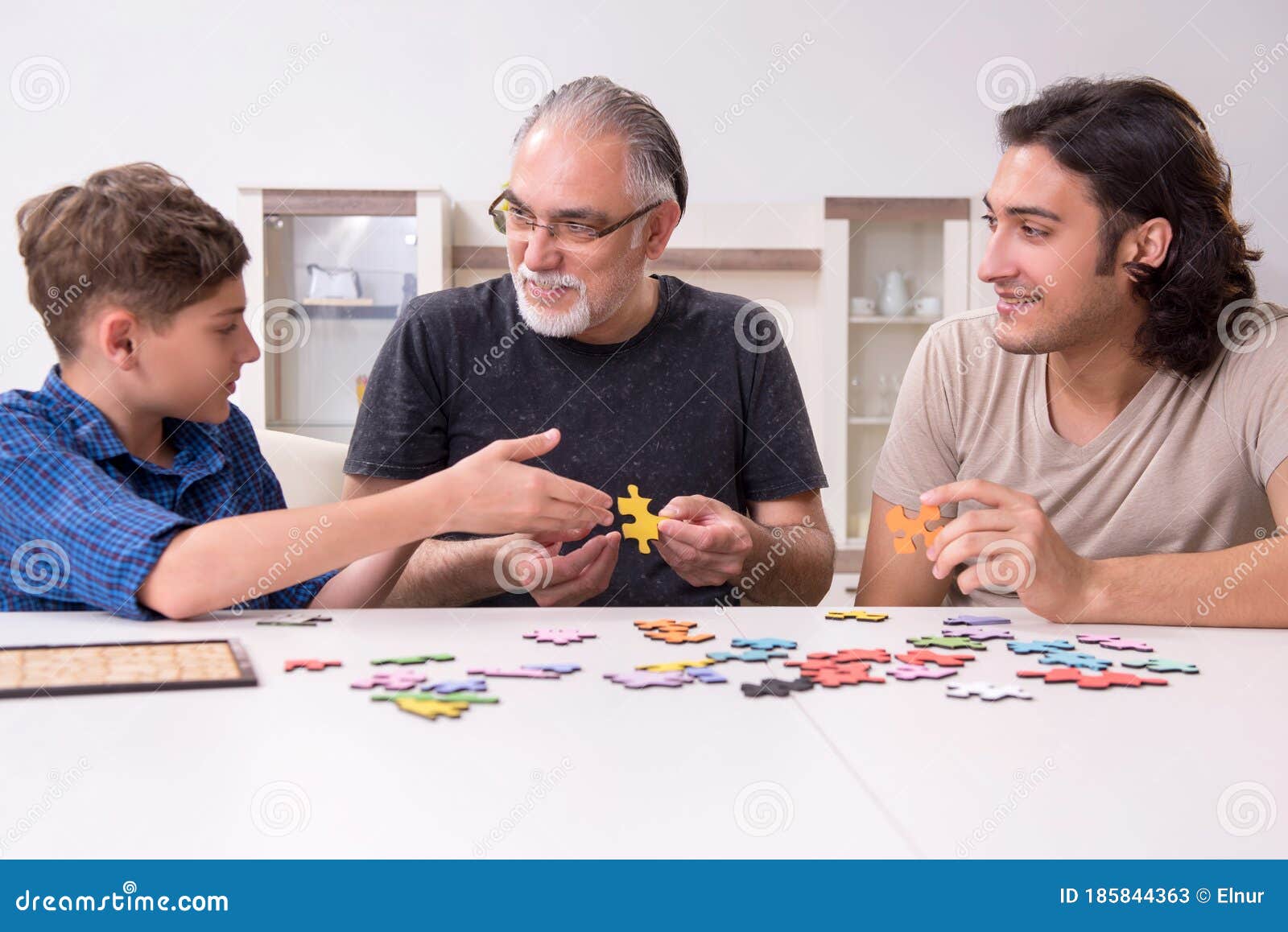 Three Generations of Family Playing Jigsaw Puzzle Game Stock Image ...
