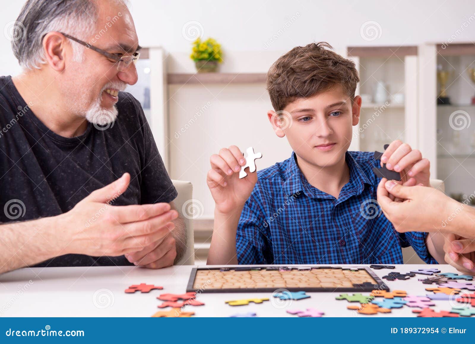 Three Generations of Family Playing Jigsaw Puzzle Game Stock Photo ...