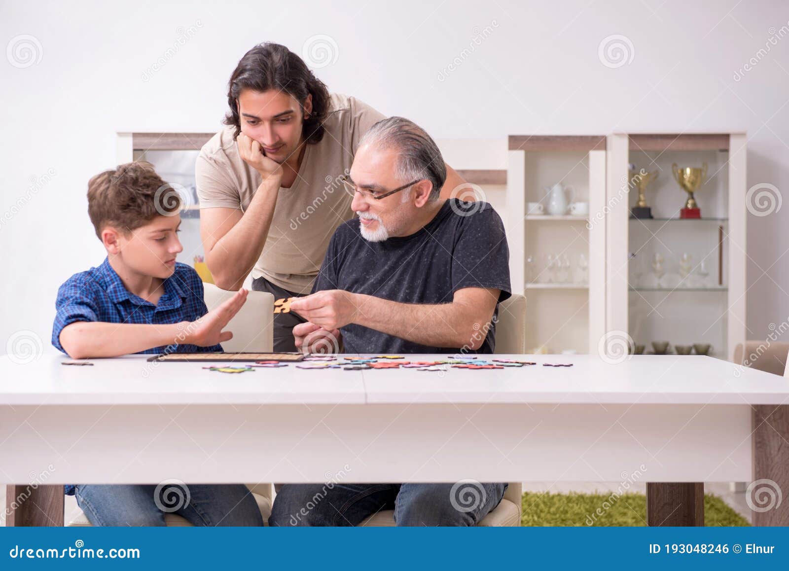 Three Generations of Family Playing Jigsaw Puzzle Game Stock Photo ...