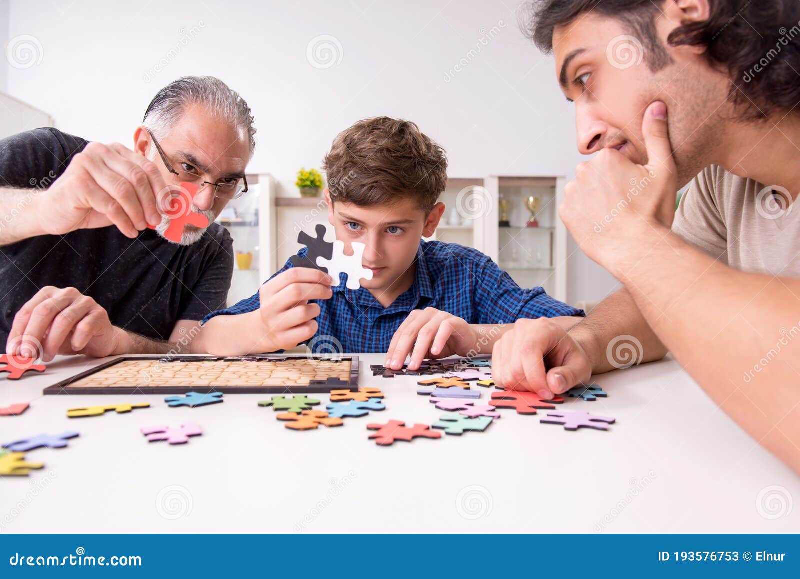 Three Generations of Family Playing Jigsaw Puzzle Game Stock Image ...