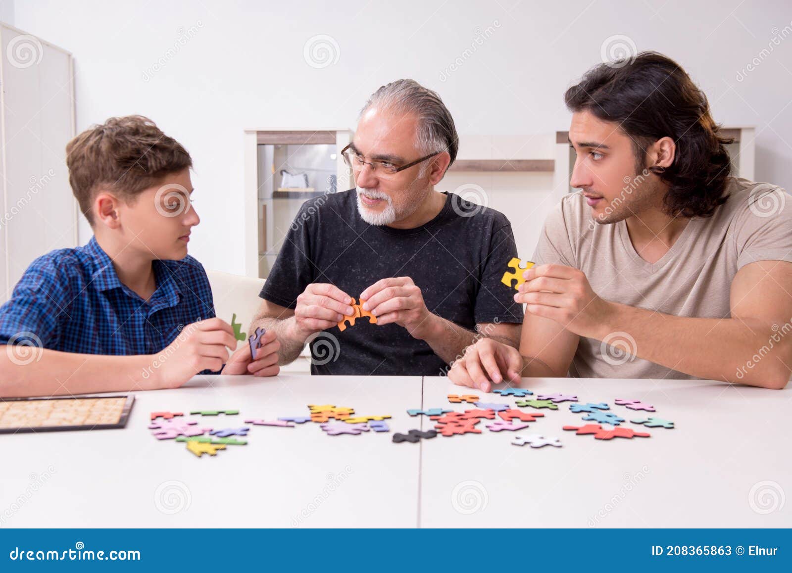 Three Generations of Family Playing Jigsaw Puzzle Game Stock Image ...