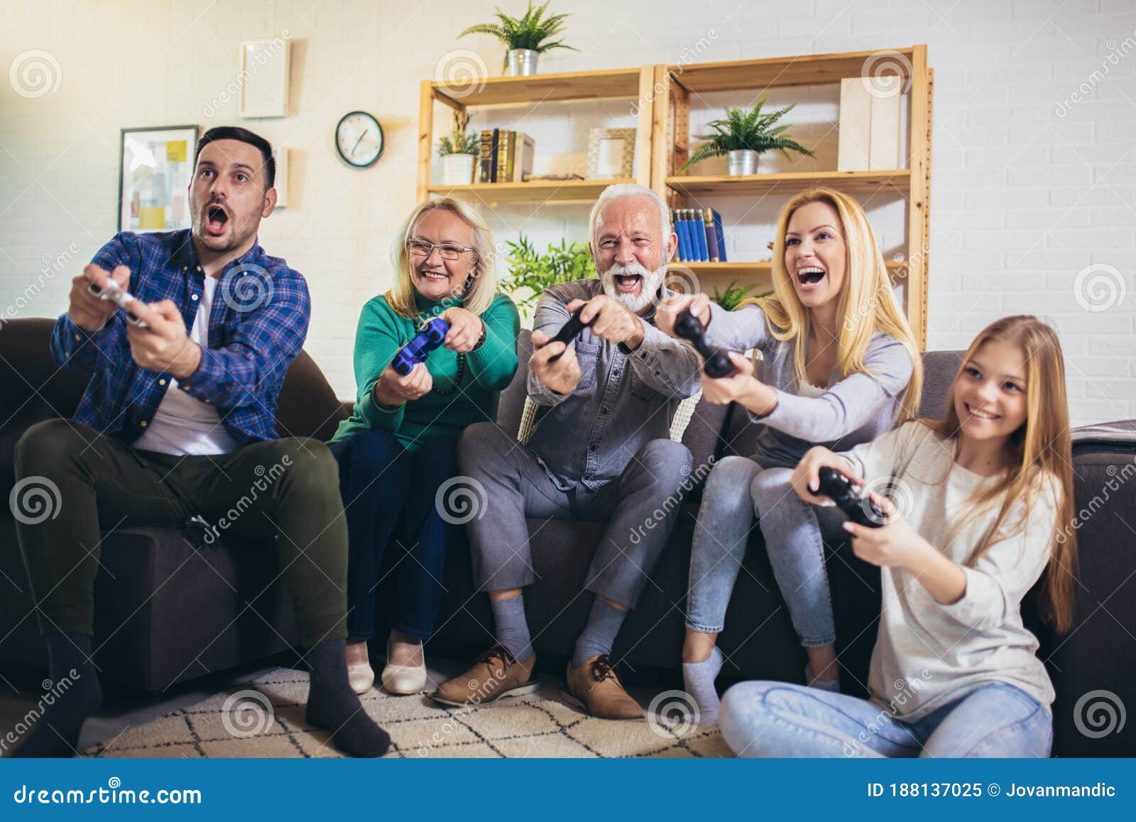 Three Generations Playing Video Games Together at Home Stock Image ...