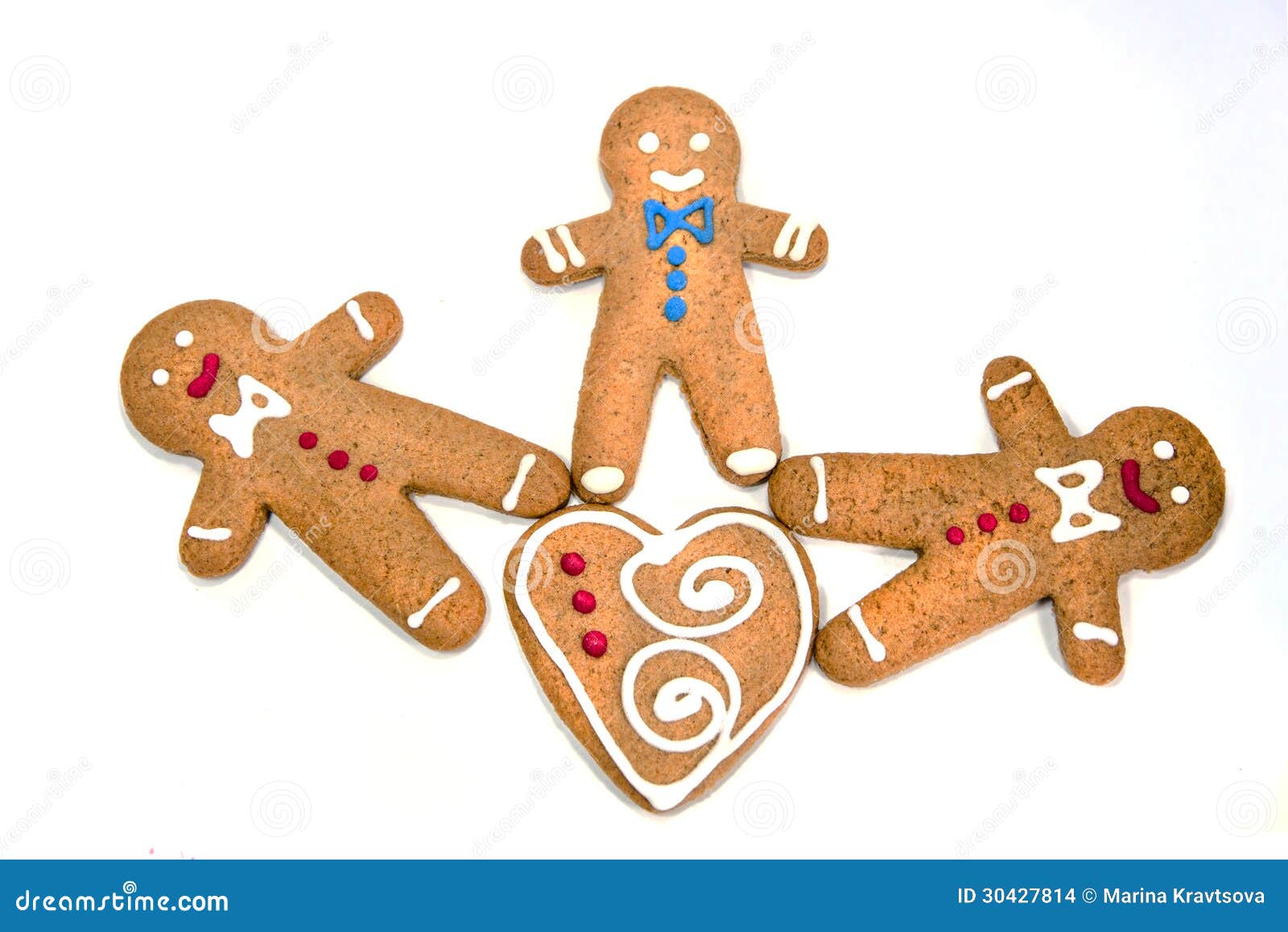 Three Gingerbread Men with a Cookie Heart Isolated Stock Photo - Image ...