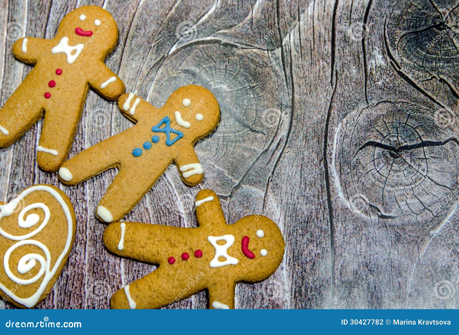 Three Gingerbread Men on Wood Stock Photo - Image of childhood, cookie ...