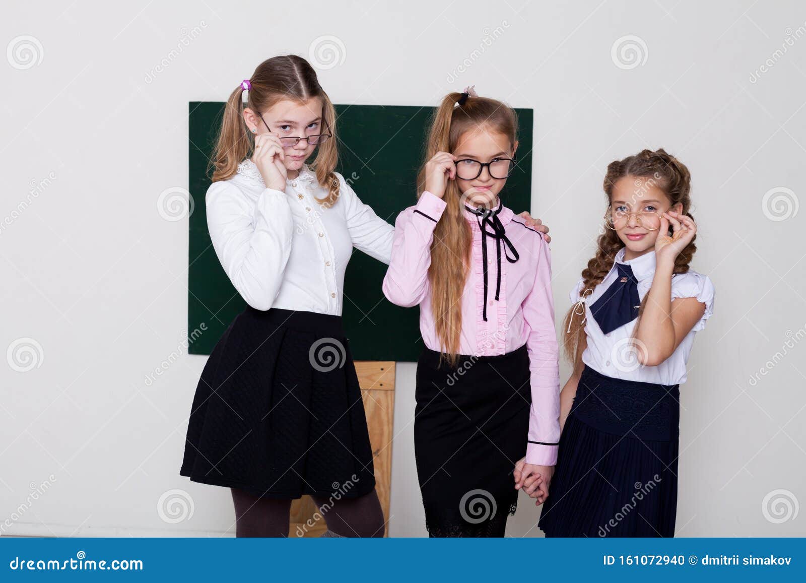 Three Girls at the Board in Class at School Stock Photo - Image of ...