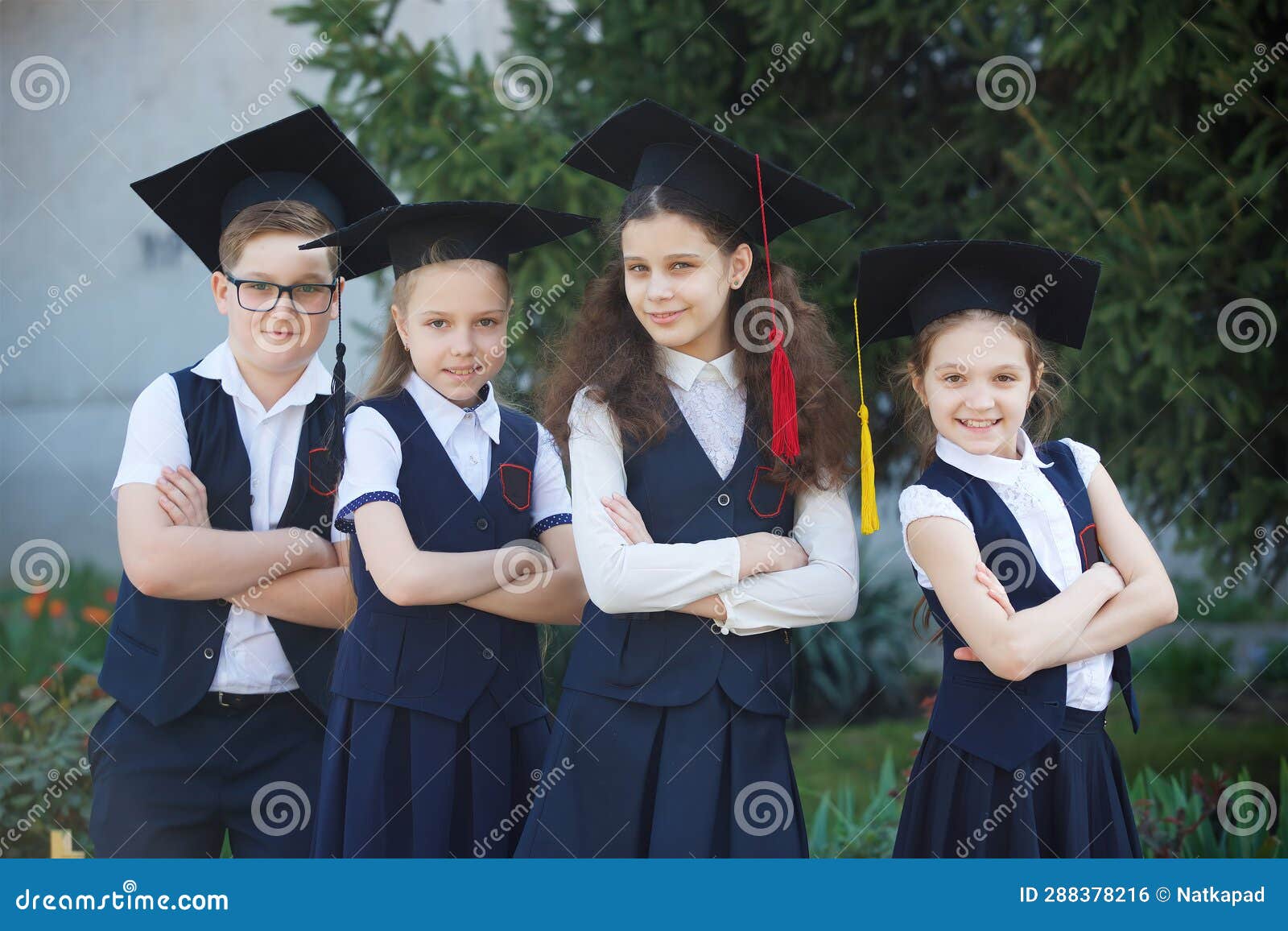 Three Girls and a Boy are Elementary School Graduates in a Graduate Hat ...