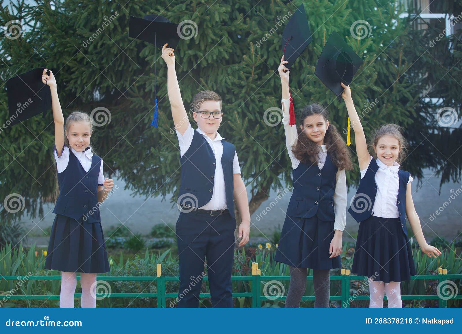 Three Girls and a Boy are Elementary School Graduates in a Graduate Hat ...