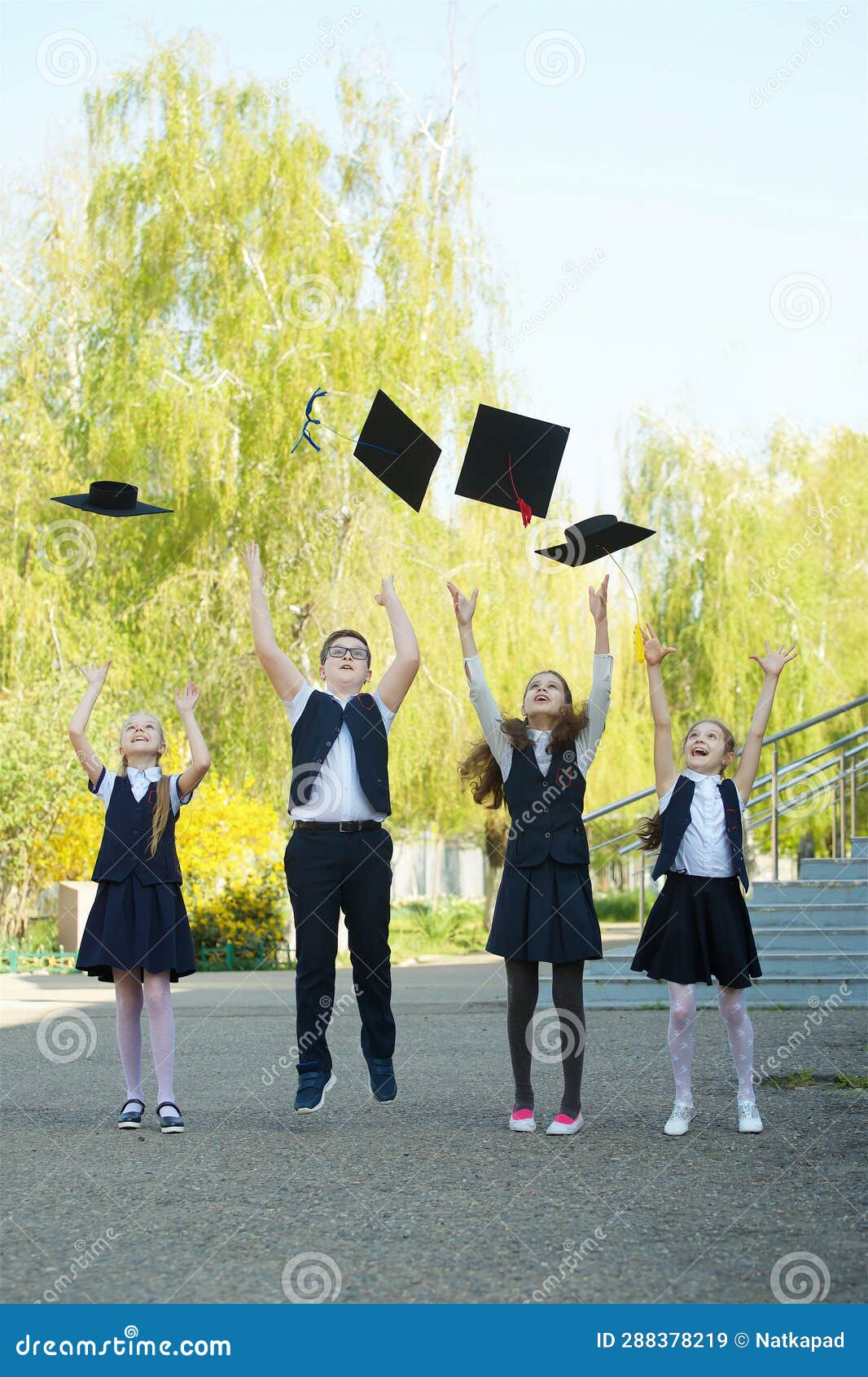 Three Girls and a Boy are Elementary School Graduates in a Graduate Hat ...