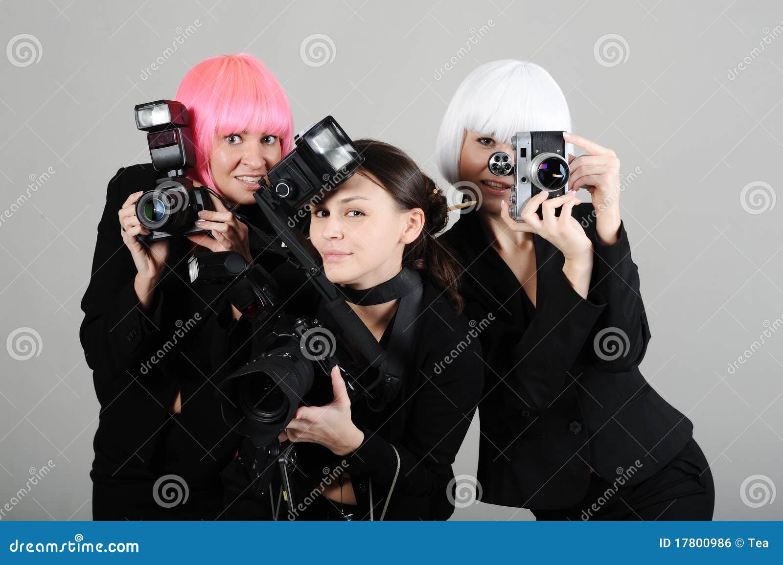 Three girls with cameras stock photo. Image of curious - 17800986