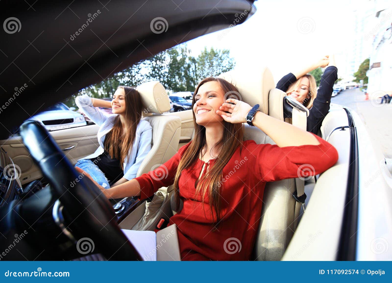 Three Girls Driving in a Convertible Car and Having Fun. Stock Photo ...