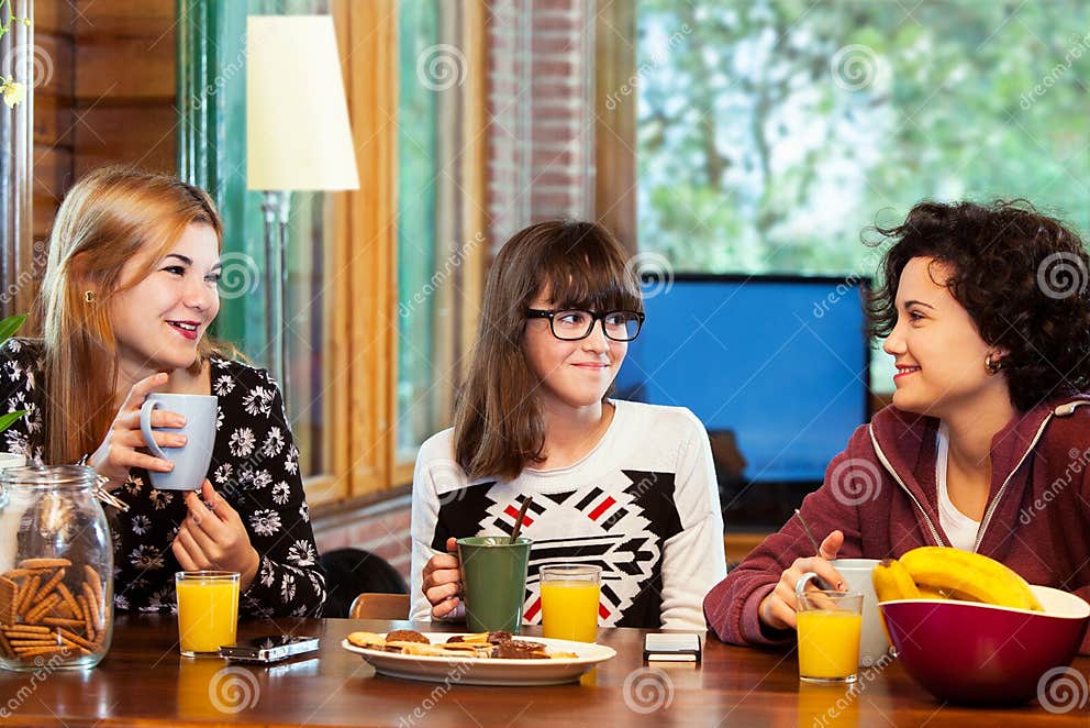 Three Girls Having Breakfeast at Home. Stock Photo - Image of girls ...