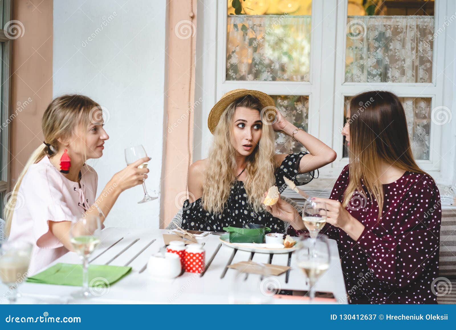 Three girls at the table stock image. Image of party - 130412637