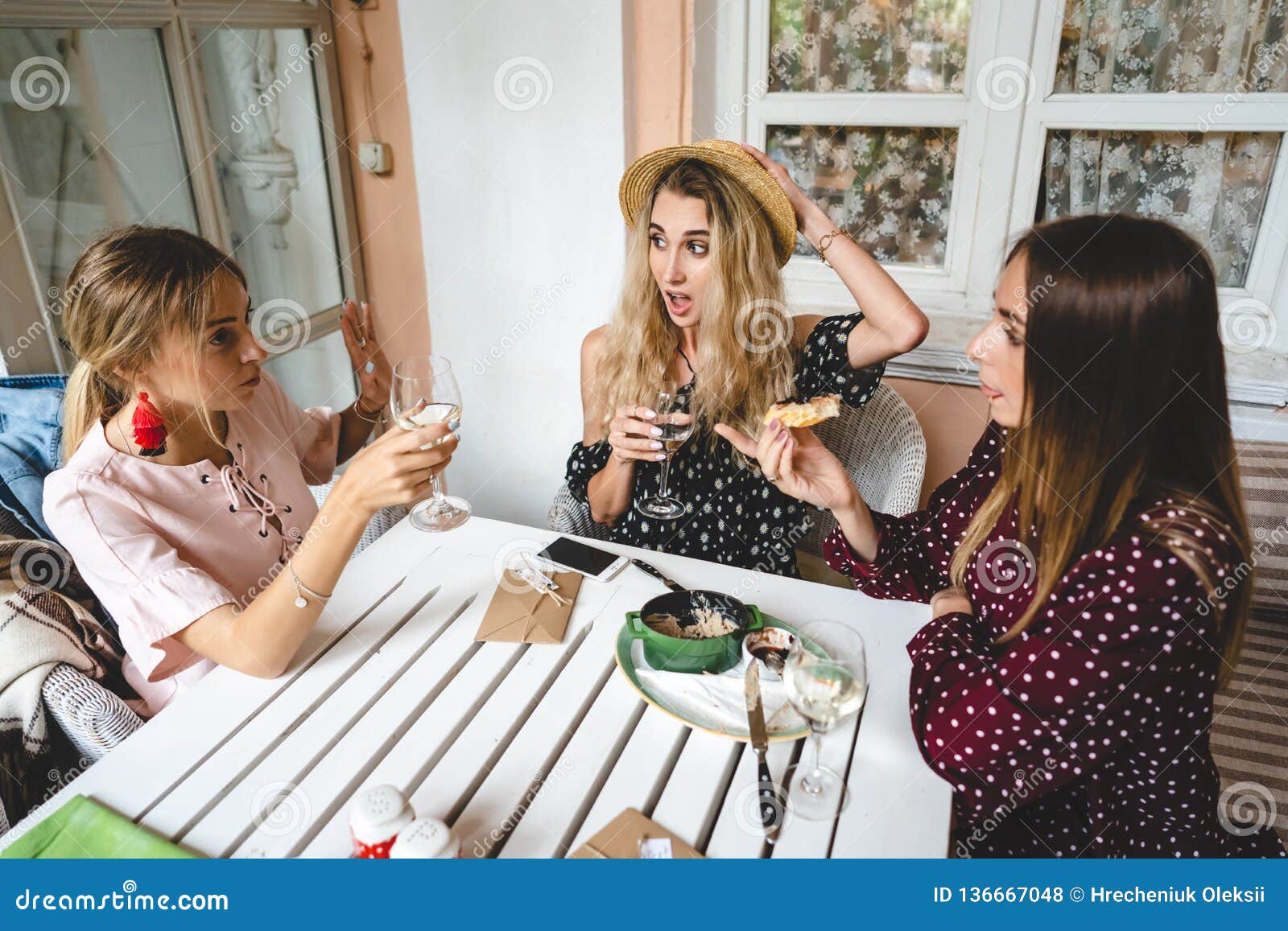 Three girls at the table stock photo. Image of sitting - 136667048
