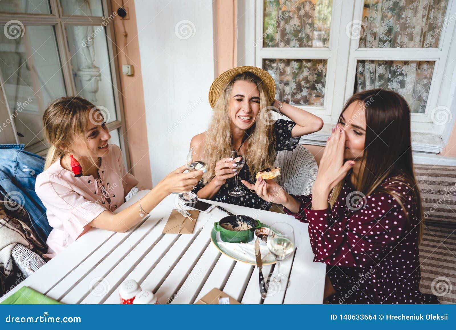 Three girls at the table stock photo. Image of friend - 140633664