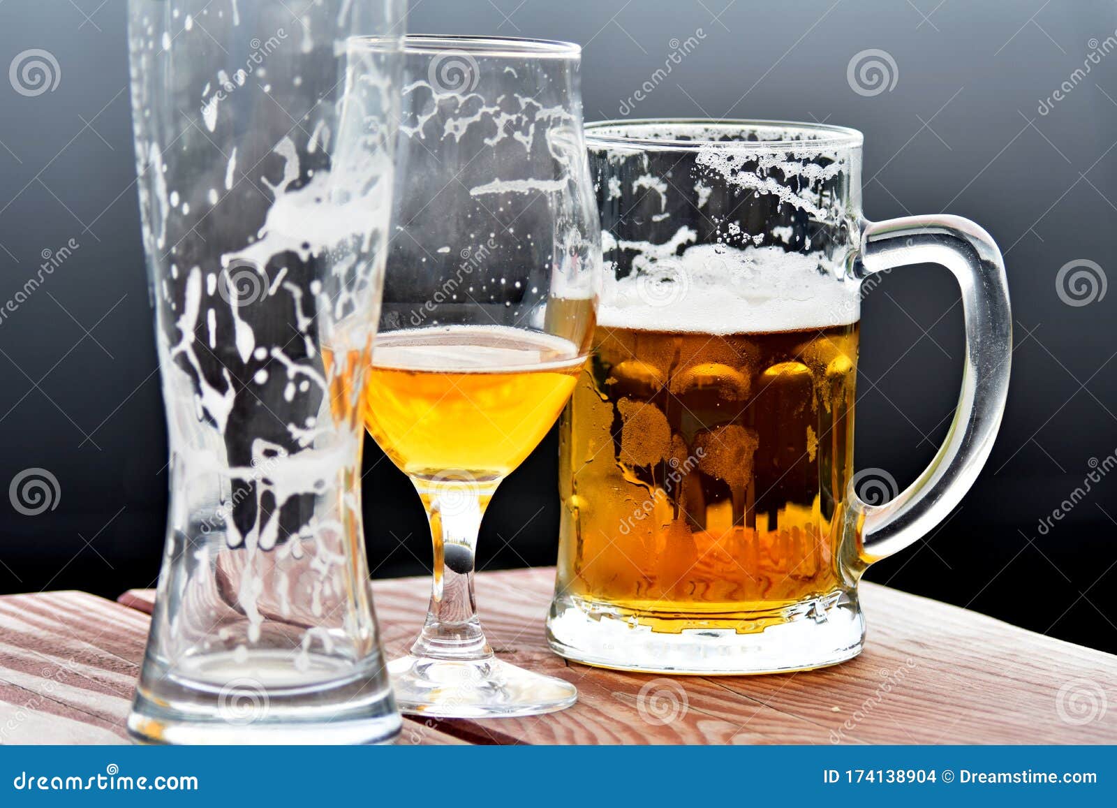Three Glass Beer Mugs on the Table - Empty, Full, Half Full Stock Photo ...