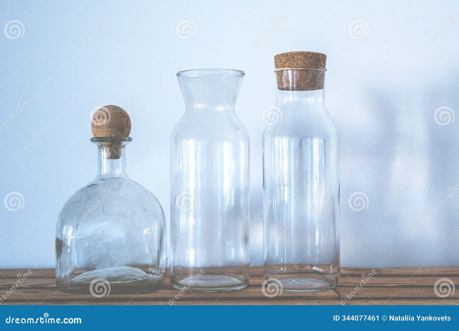 Three Glass Bottles of Different Shapes on a White Background. Empty ...