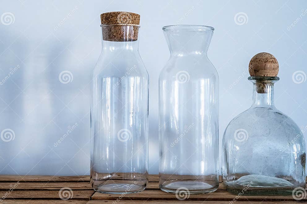 Three Glass Bottles of Different Shapes on a White Background. Empty ...