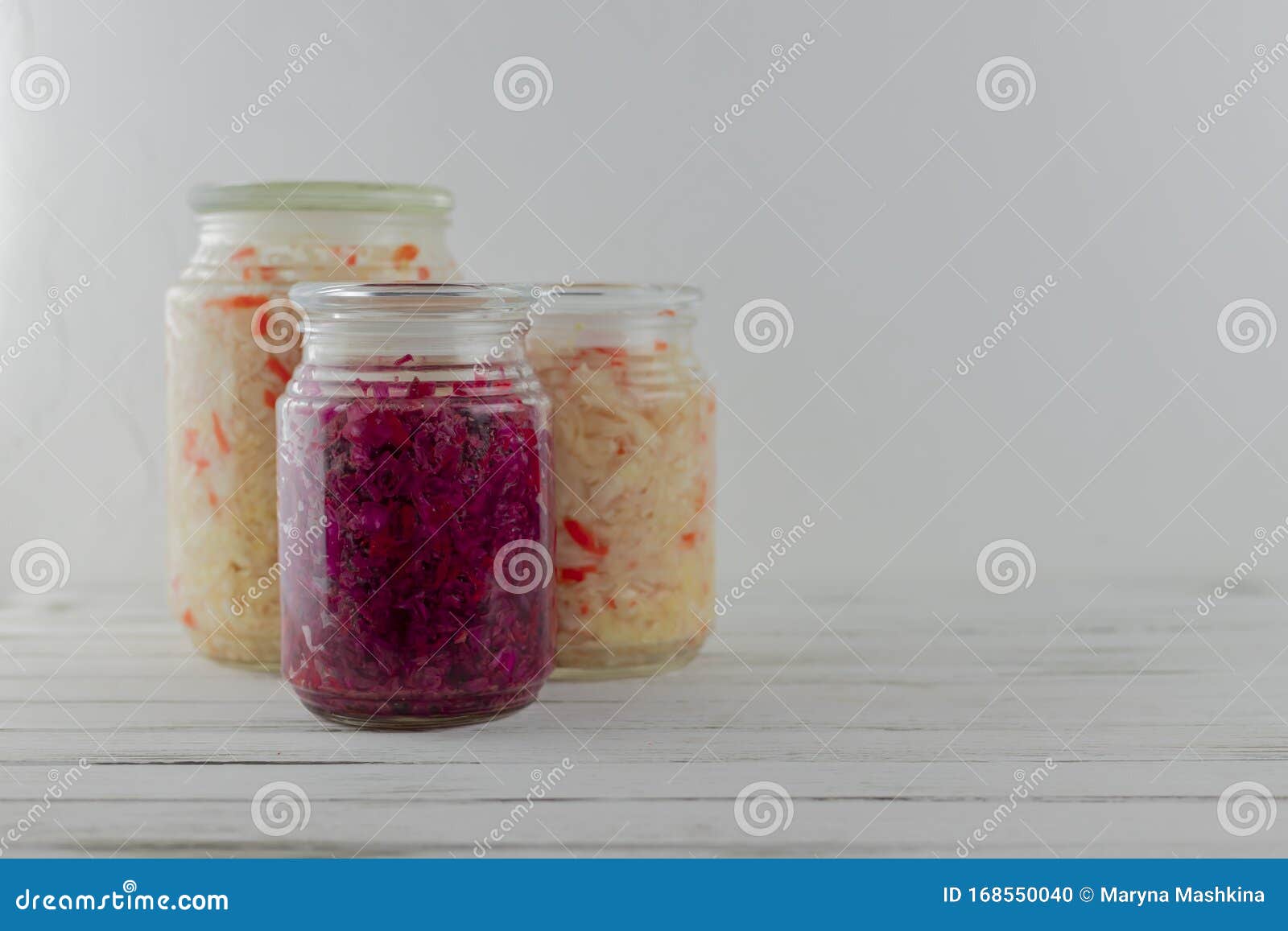 Three Glass Jars of Fermented White, Red Cabbage. Vegetables on a Light ...