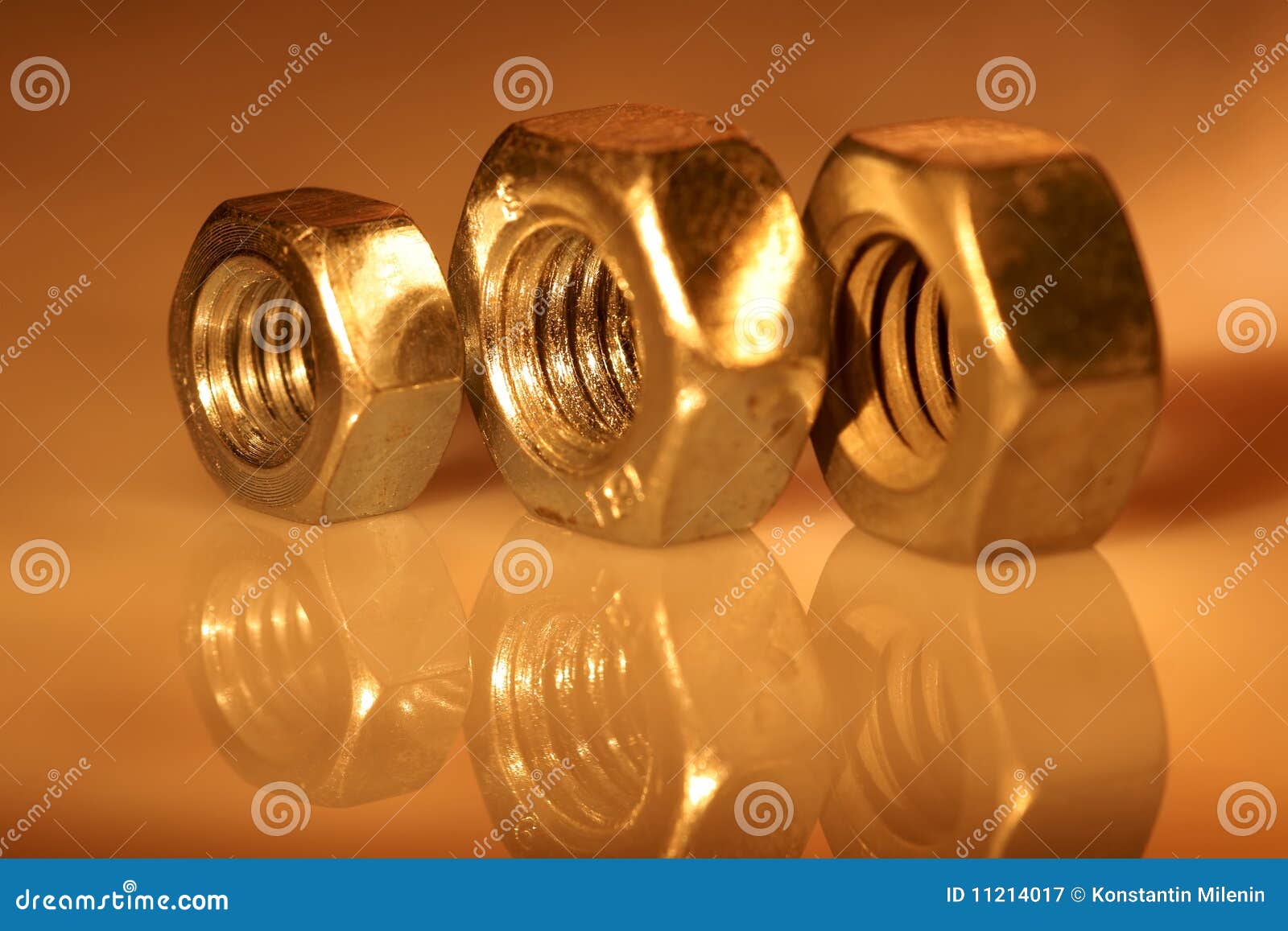 Three gold nuts. stock image. Image of hardware, nuts - 11214017