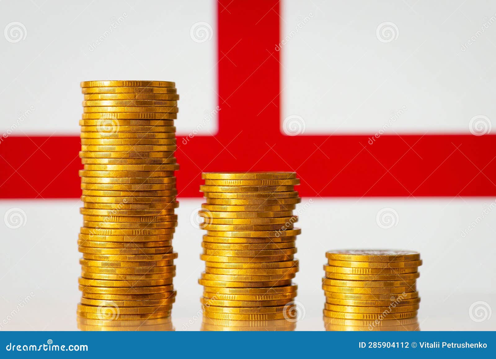 Three Golden Coin Stacks from Highest To Lowest Against Flag of England ... Three Golden Coin Stacks from Highest To Lowest Against Flag of England ...