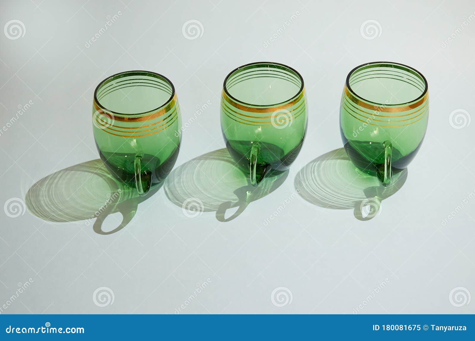 Three Green Glass Cups with Handles Stand in a Row Stock Image - Image ...