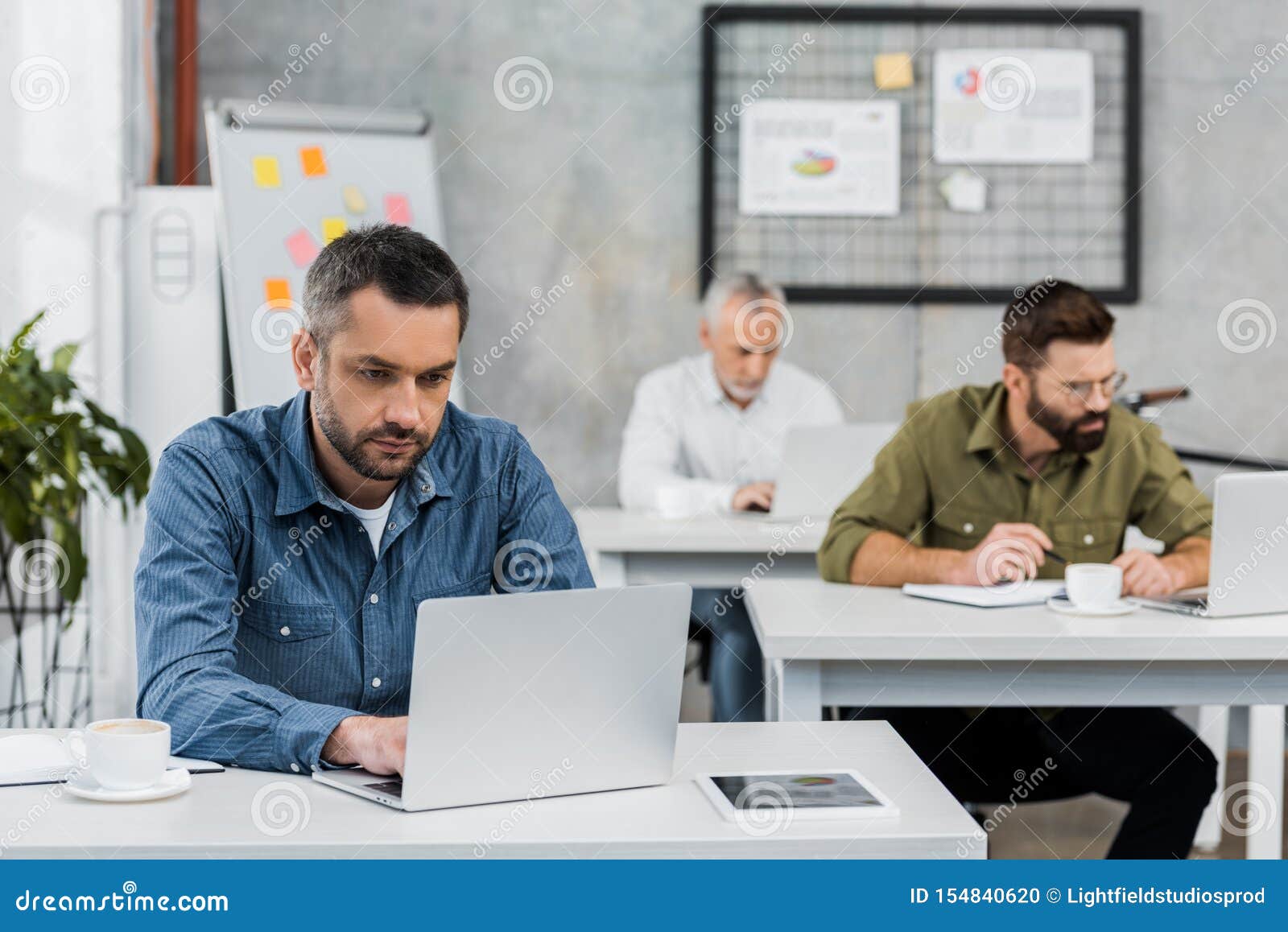 Three Handsome Businessmen Working at Laptops Stock Photo - Image of ...