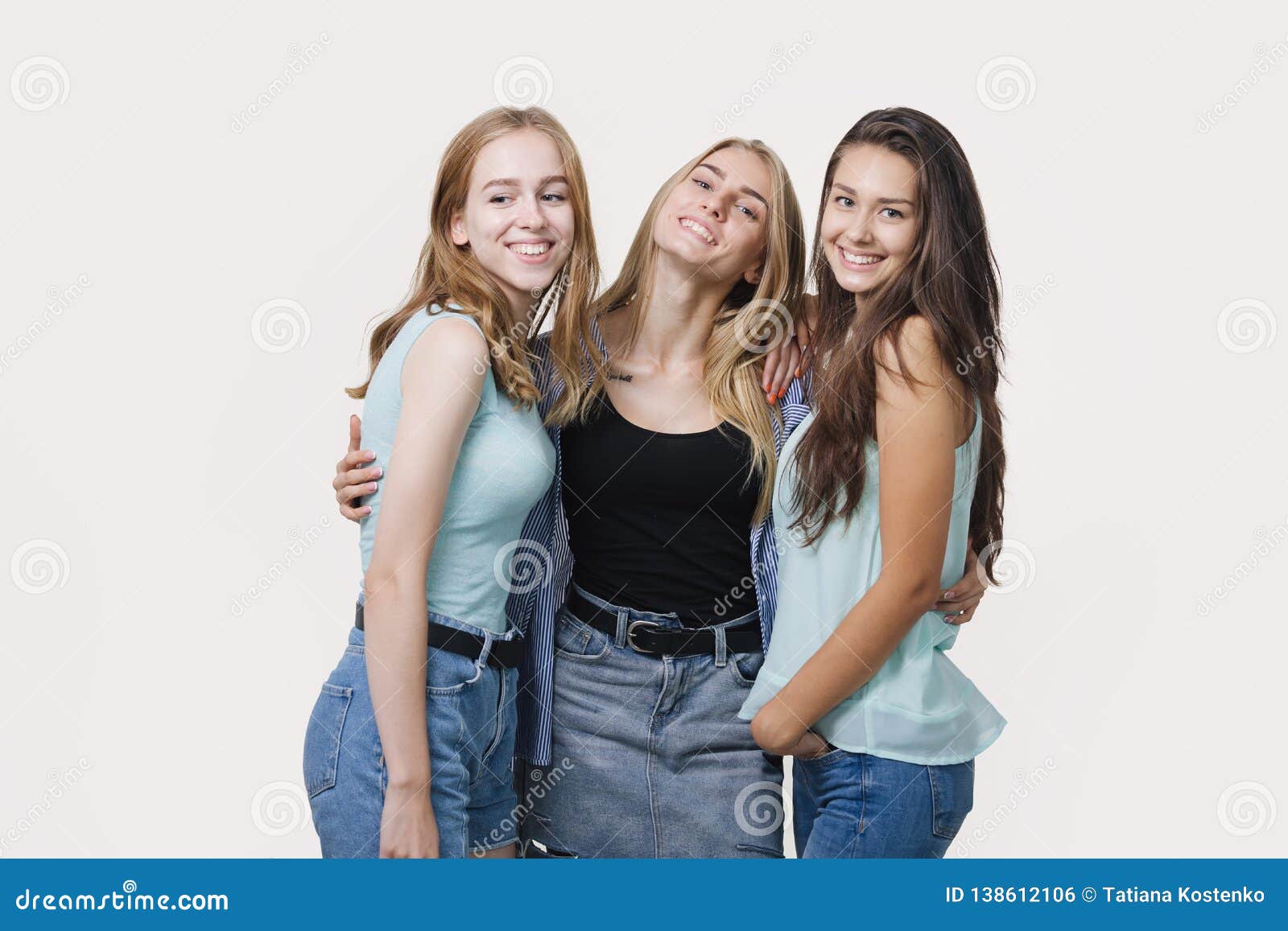 Three Happy Girls Dressed in Casual Style Pose in the Studio Stock ...